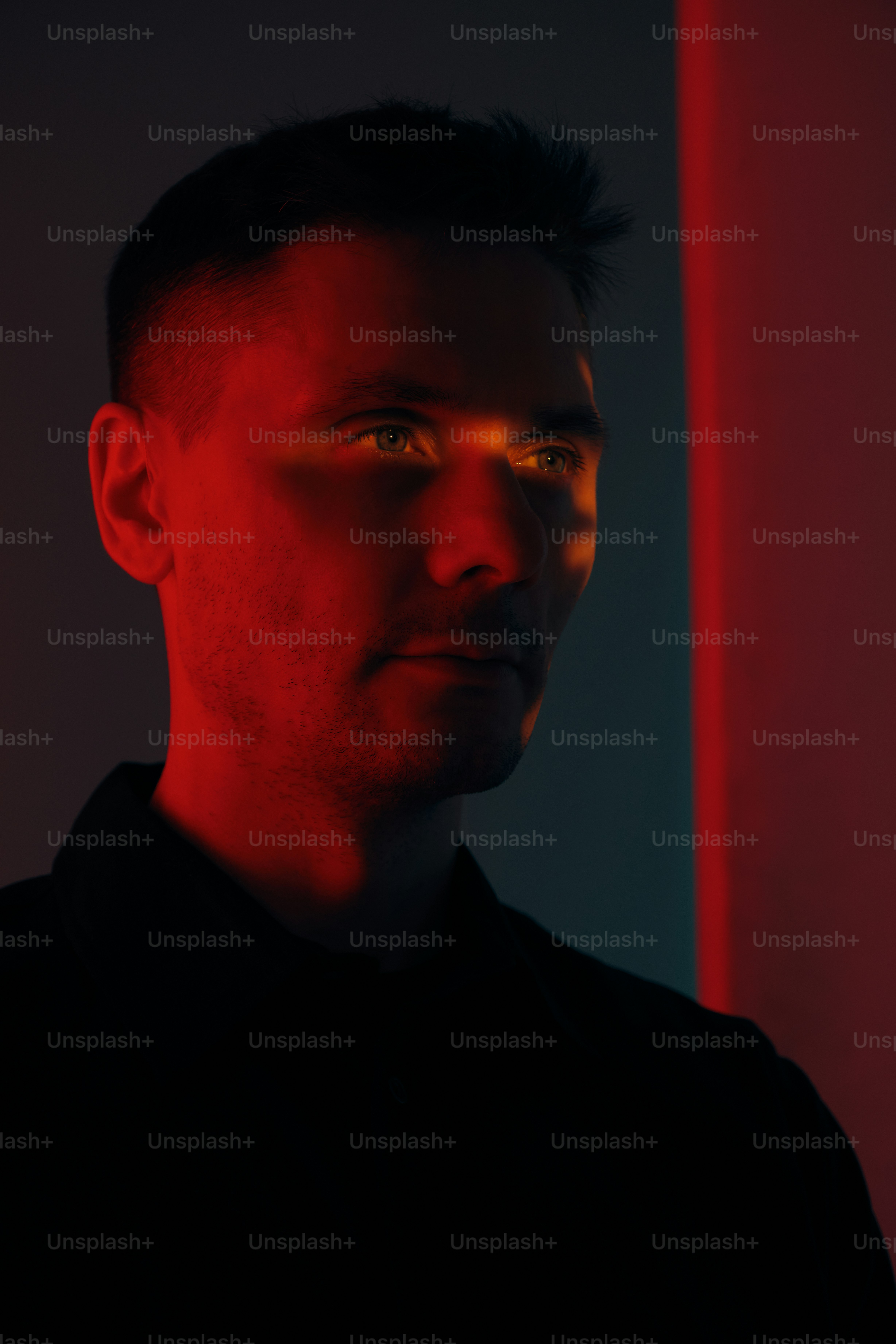 A man is illuminated by red and gold light. photo – Portrait Image on ...