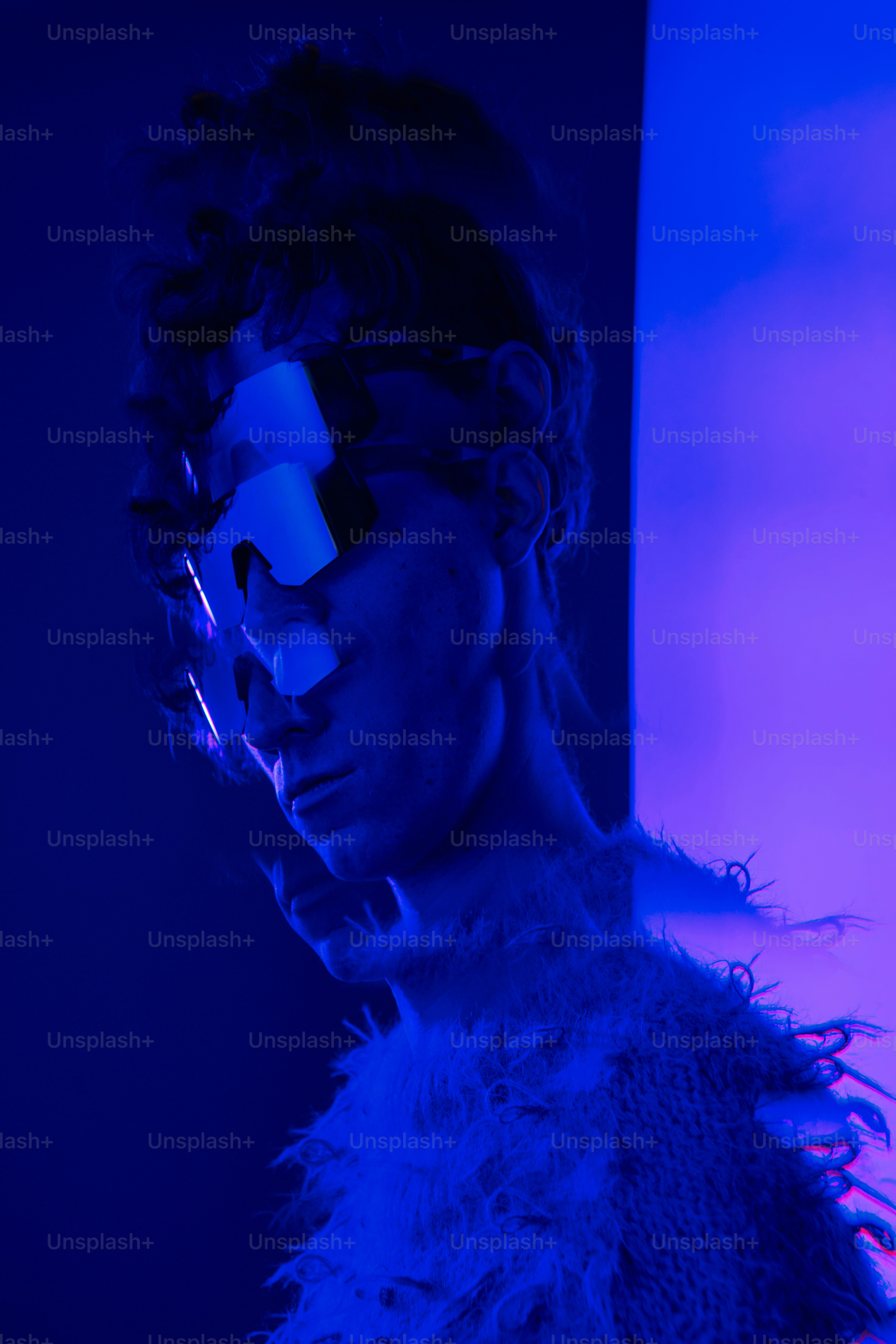 A person poses with a blue-lit face and costume. photo – Portrait Image ...