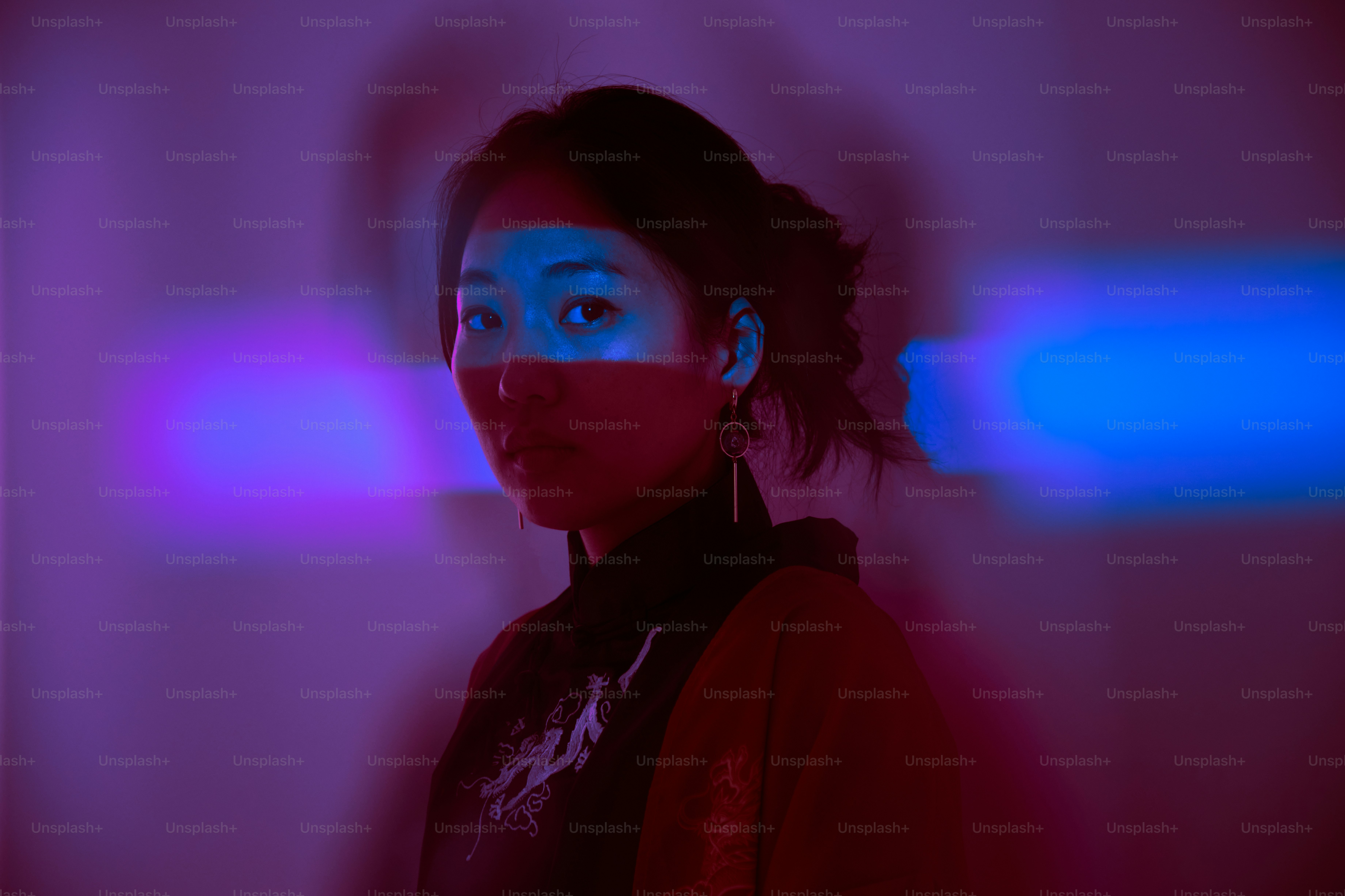 A woman looks into the camera with neon lighting. photo – Portrait ...