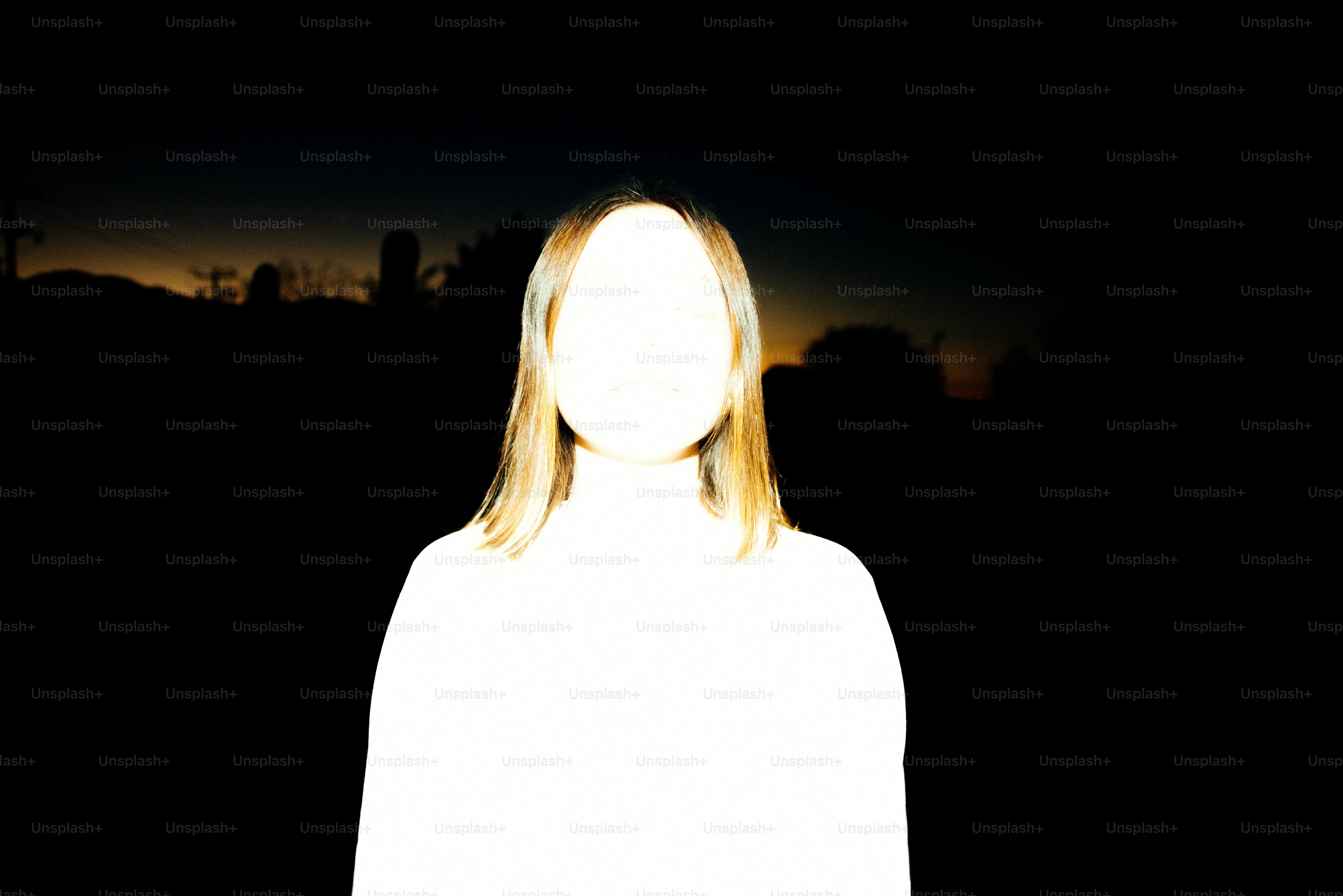 A bright figure is shown in the dark setting. photo – Flash Image on ...