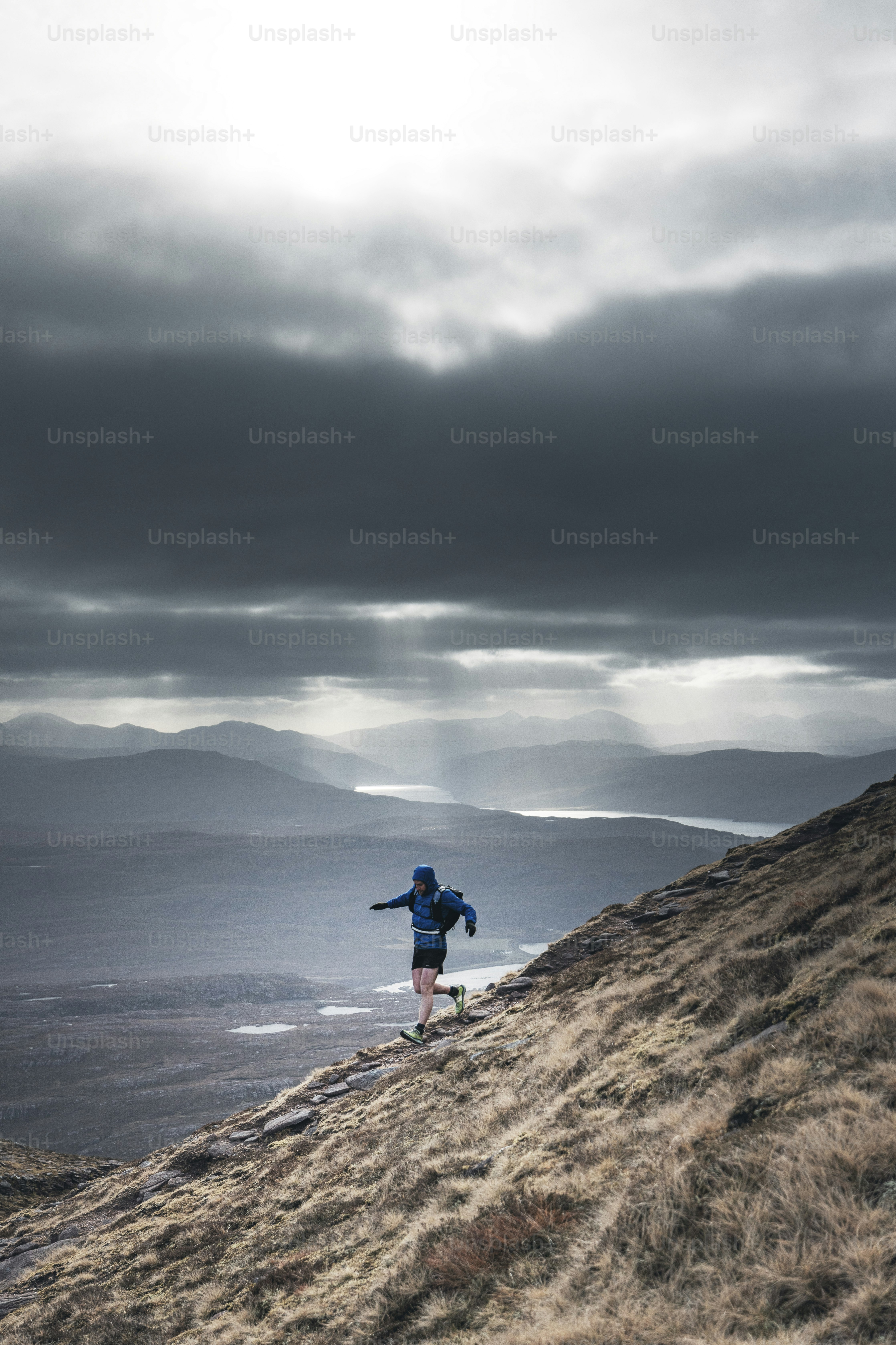 Runner ascends mountain against a dramatic sky. photo – Wallpaper Image ...