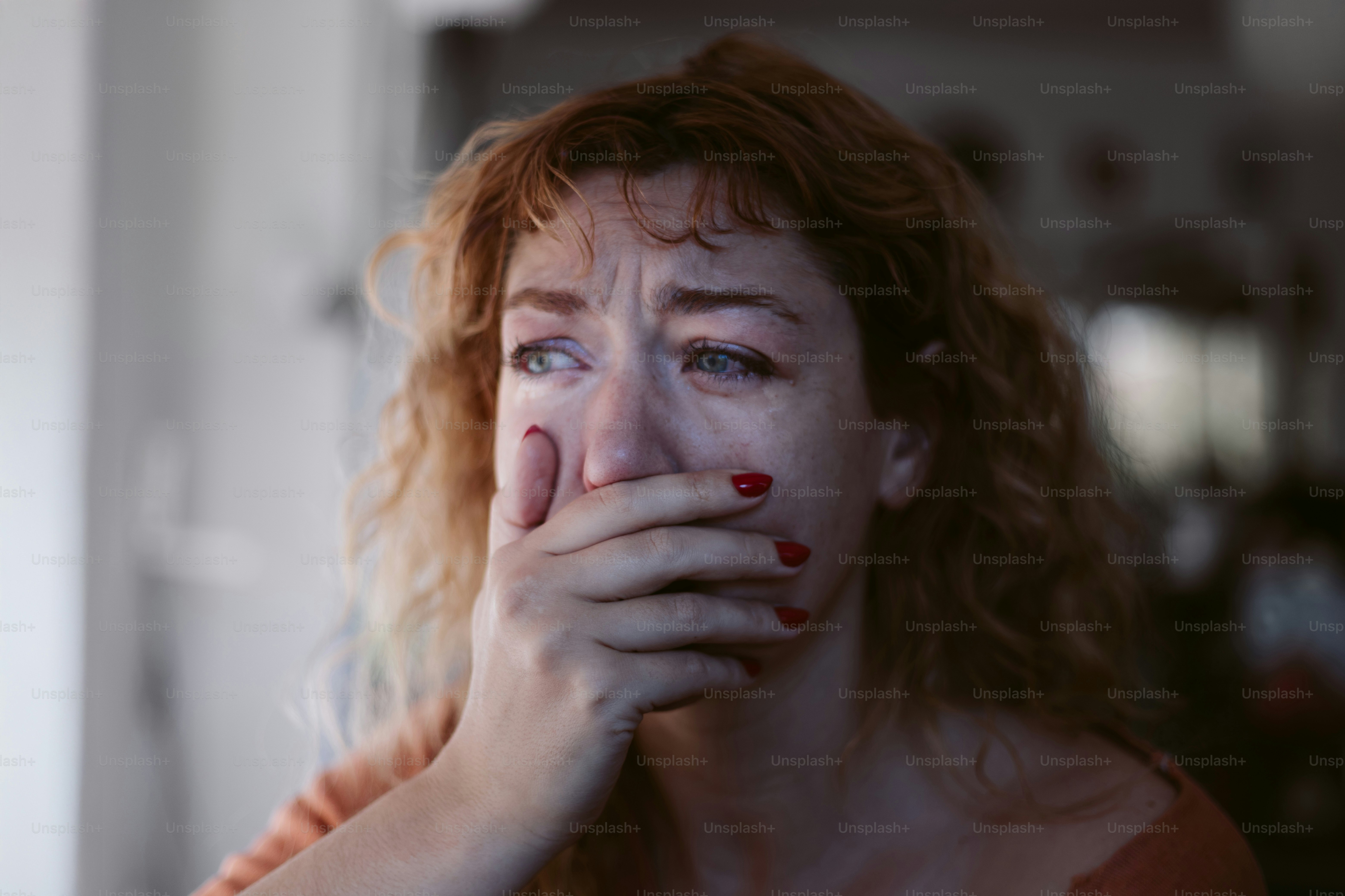A woman is crying with her hand over her mouth. photo – Depression ...
