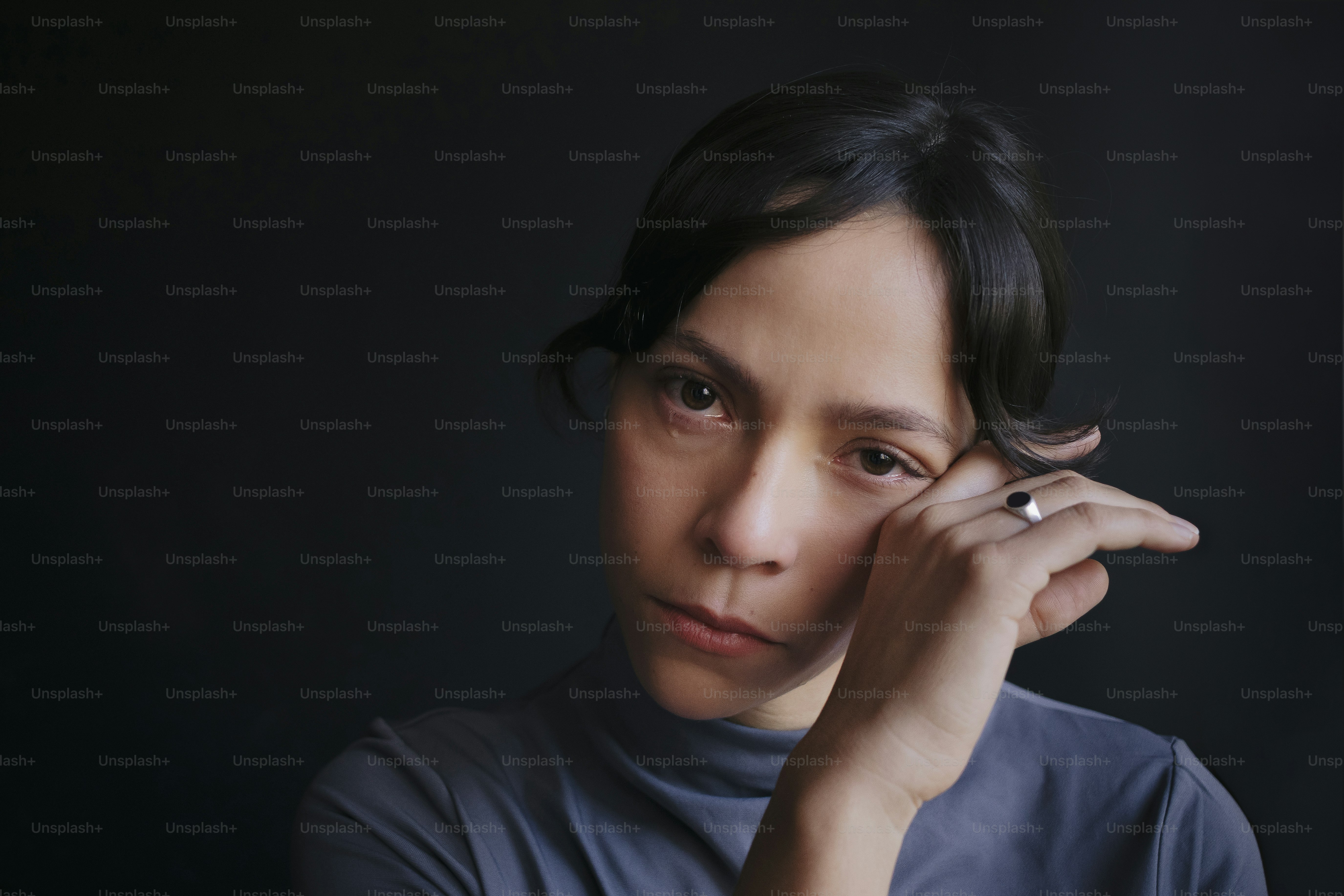 Woman appears to be wiping a tear. photo – Mental health Image on Unsplash