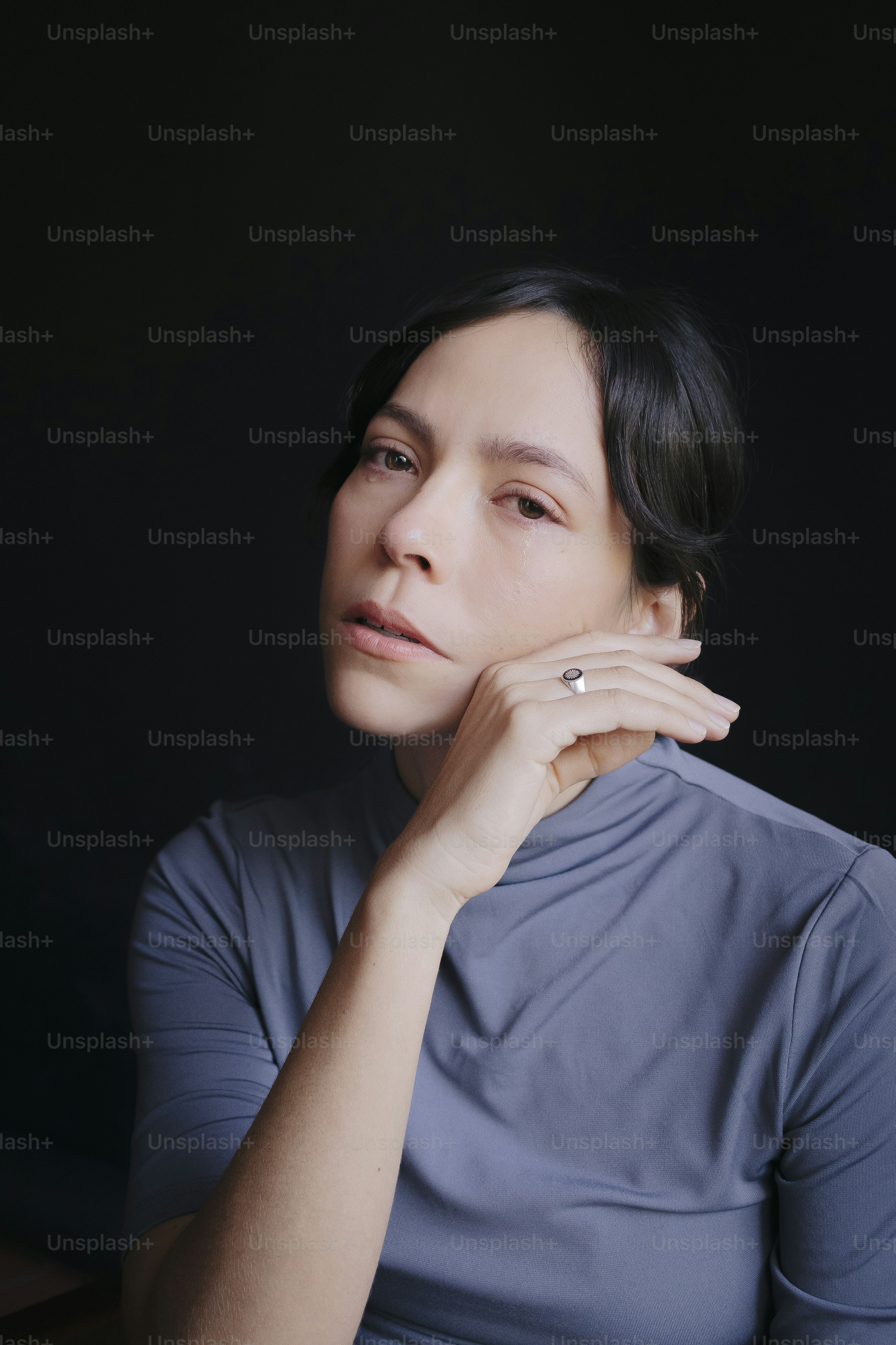 Woman appears to be wiping a tear. photo – Mental health Image on Unsplash