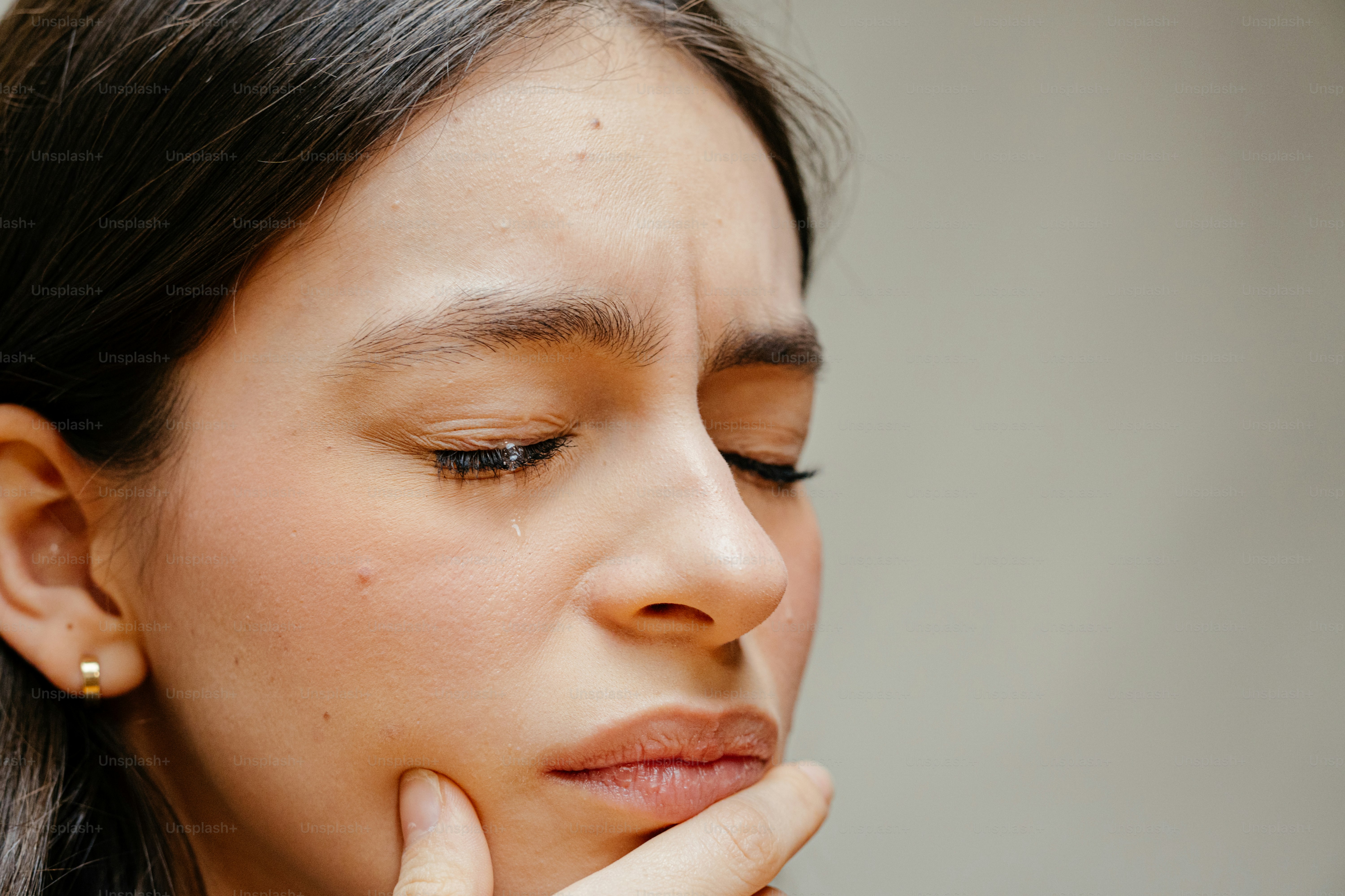 Woman looks contemplative or concerned with her eyes closed. photo ...