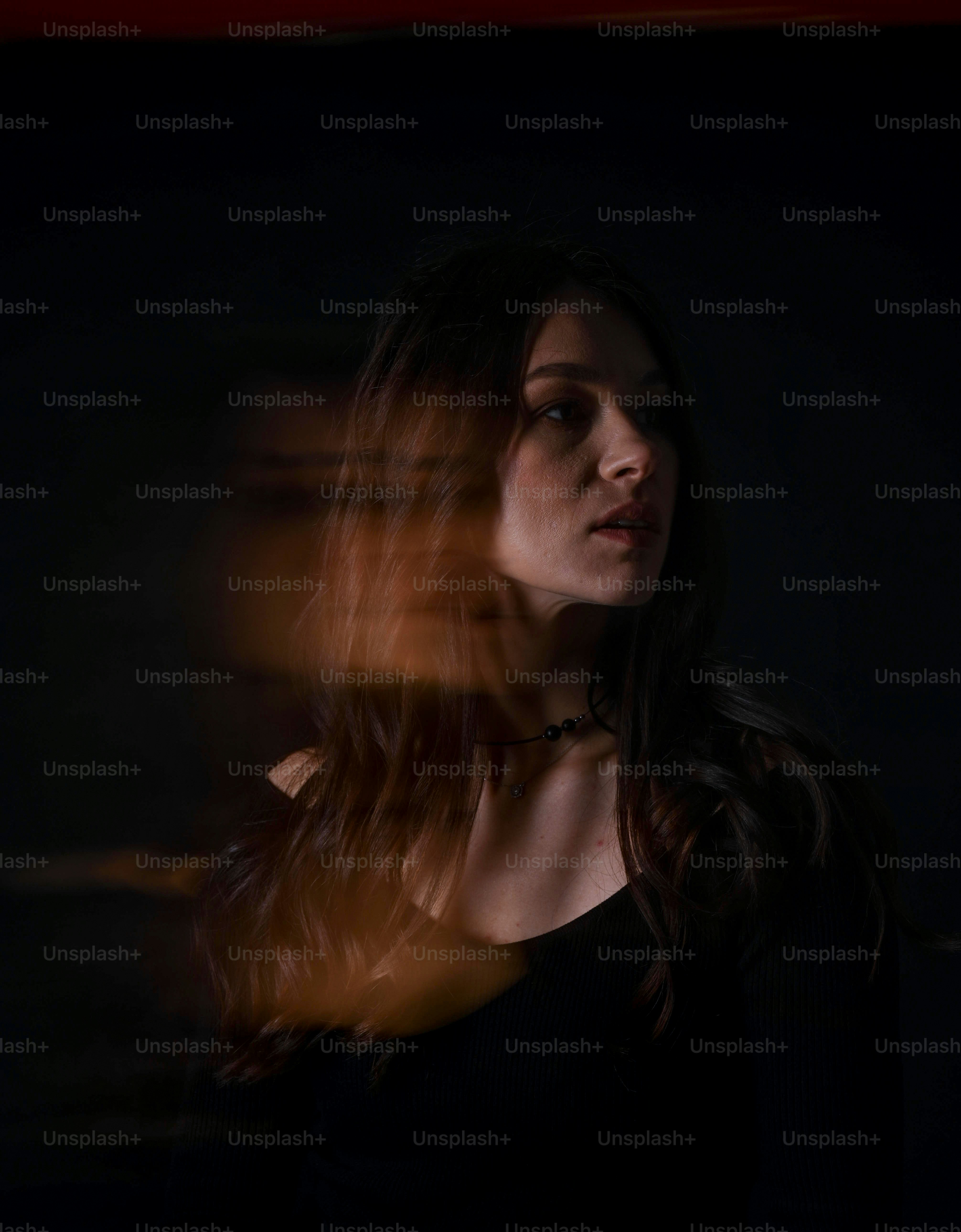 A young woman looks away with thoughtful expression. photo – Portrait ...