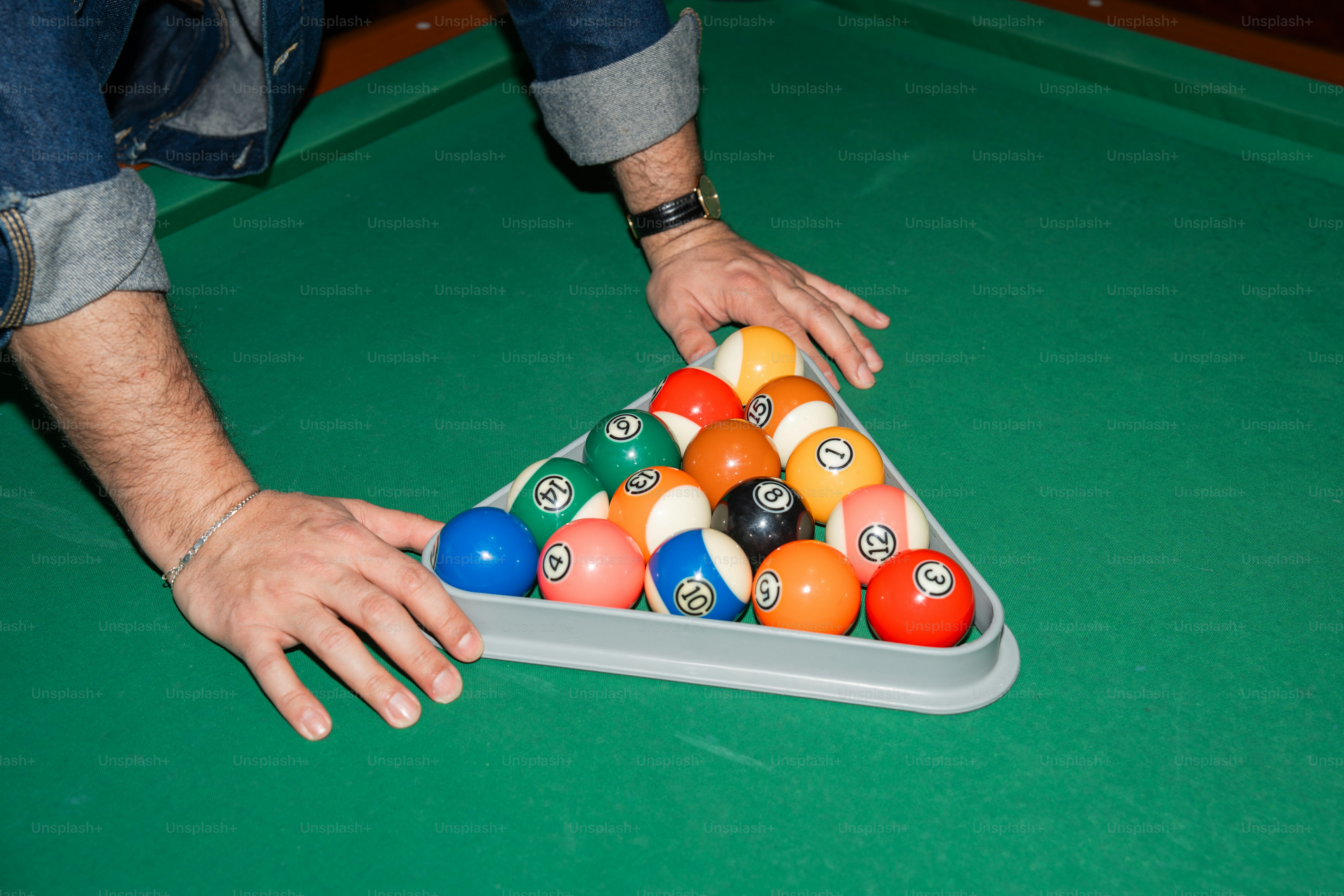 Someone is racking the pool balls. photo – Friends Image on Unsplash