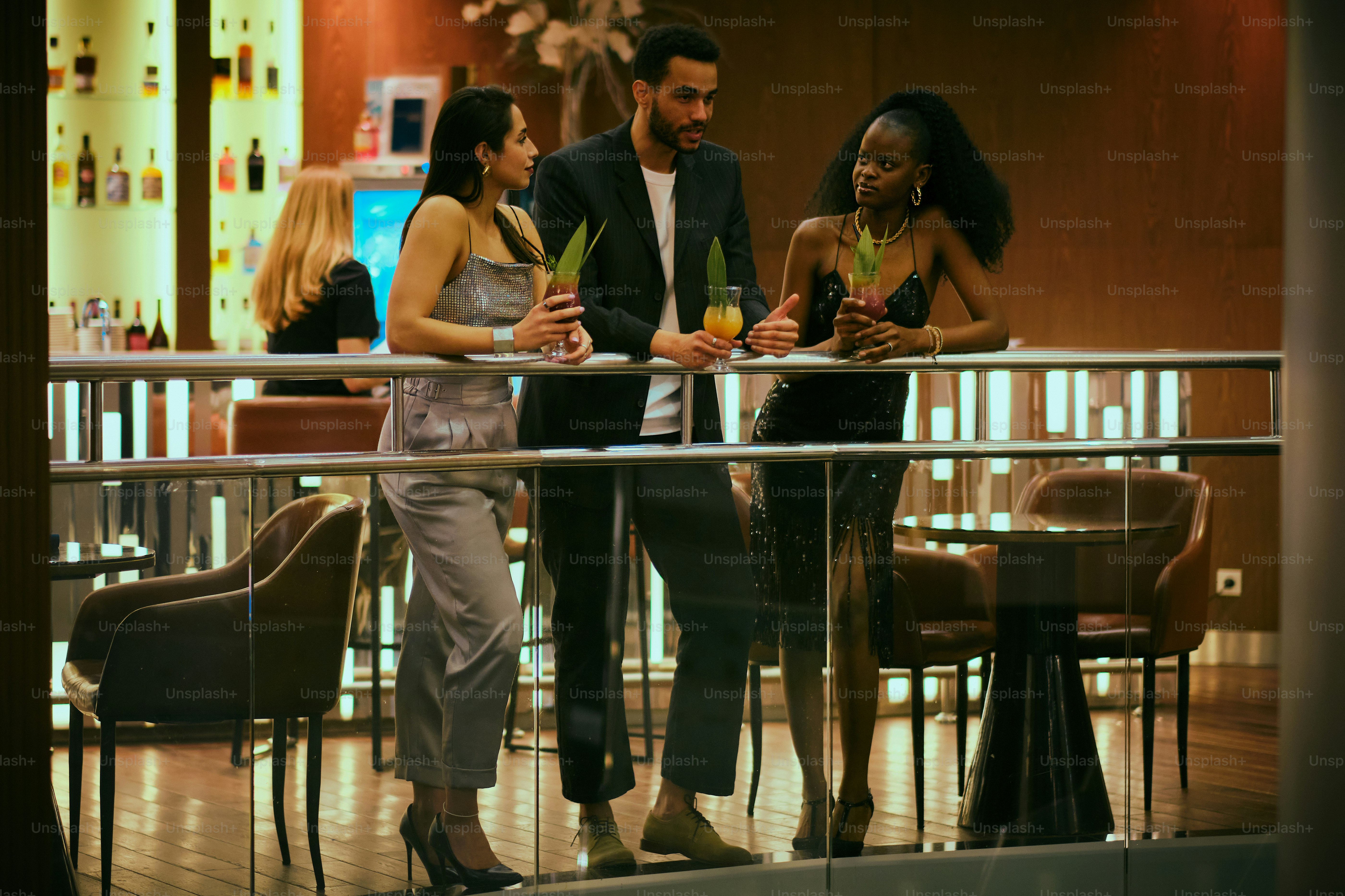 People socializing and drinking cocktails at a bar. photo – People ...