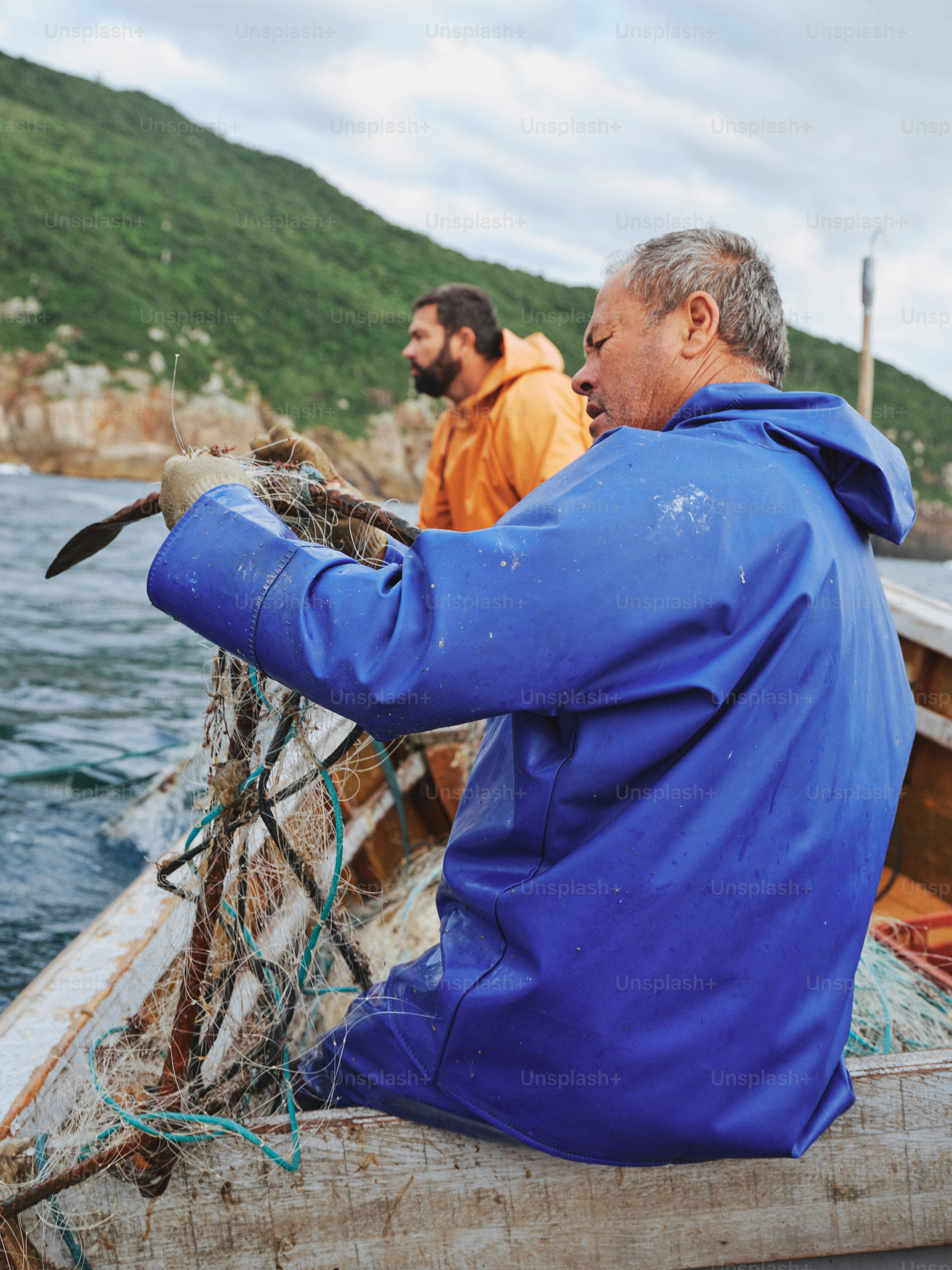 Fishermen are at sea, pulling in their nets. photo – Portrait Image on ...