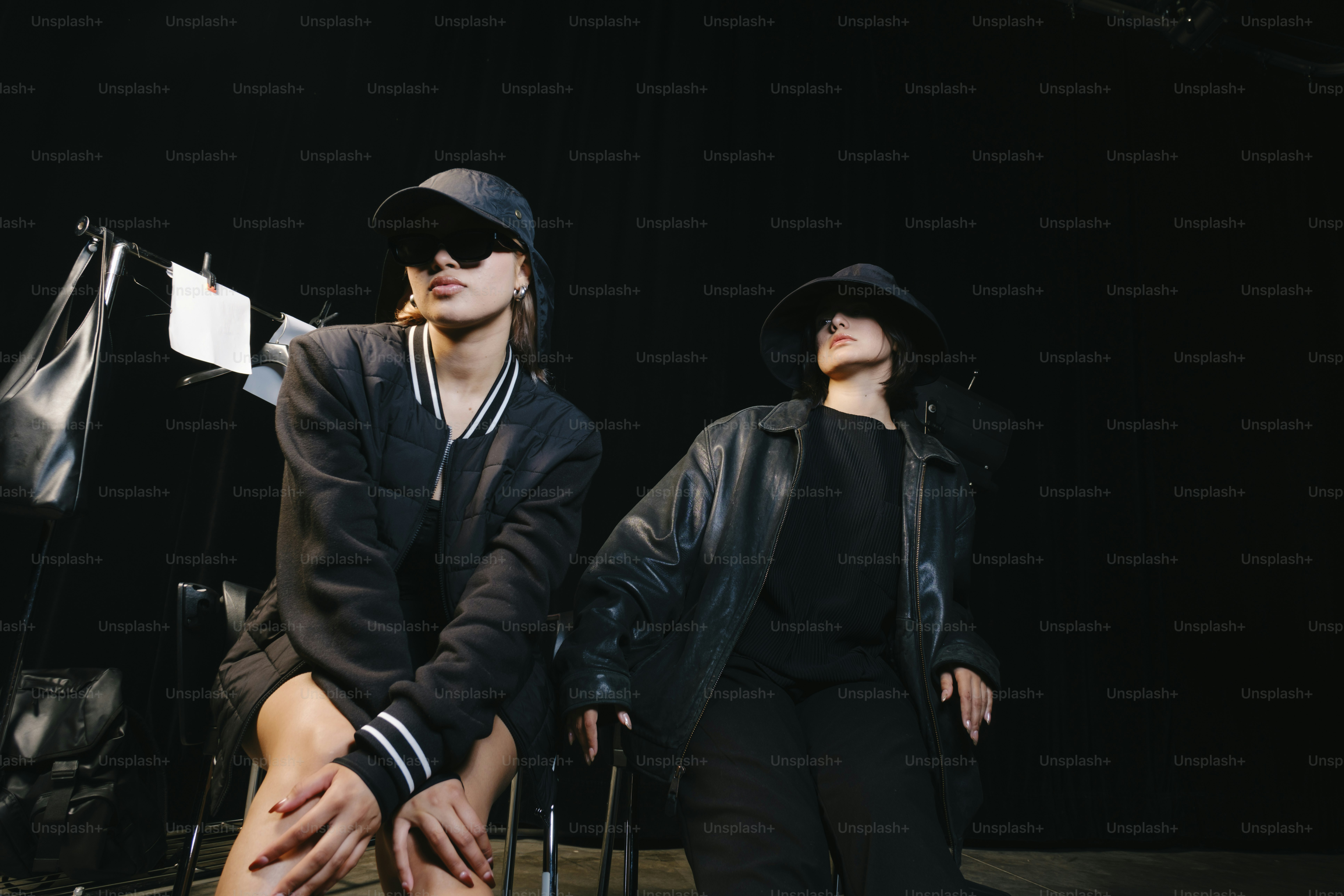 Two people sit in a darkly lit room. photo – Fashion Image on Unsplash