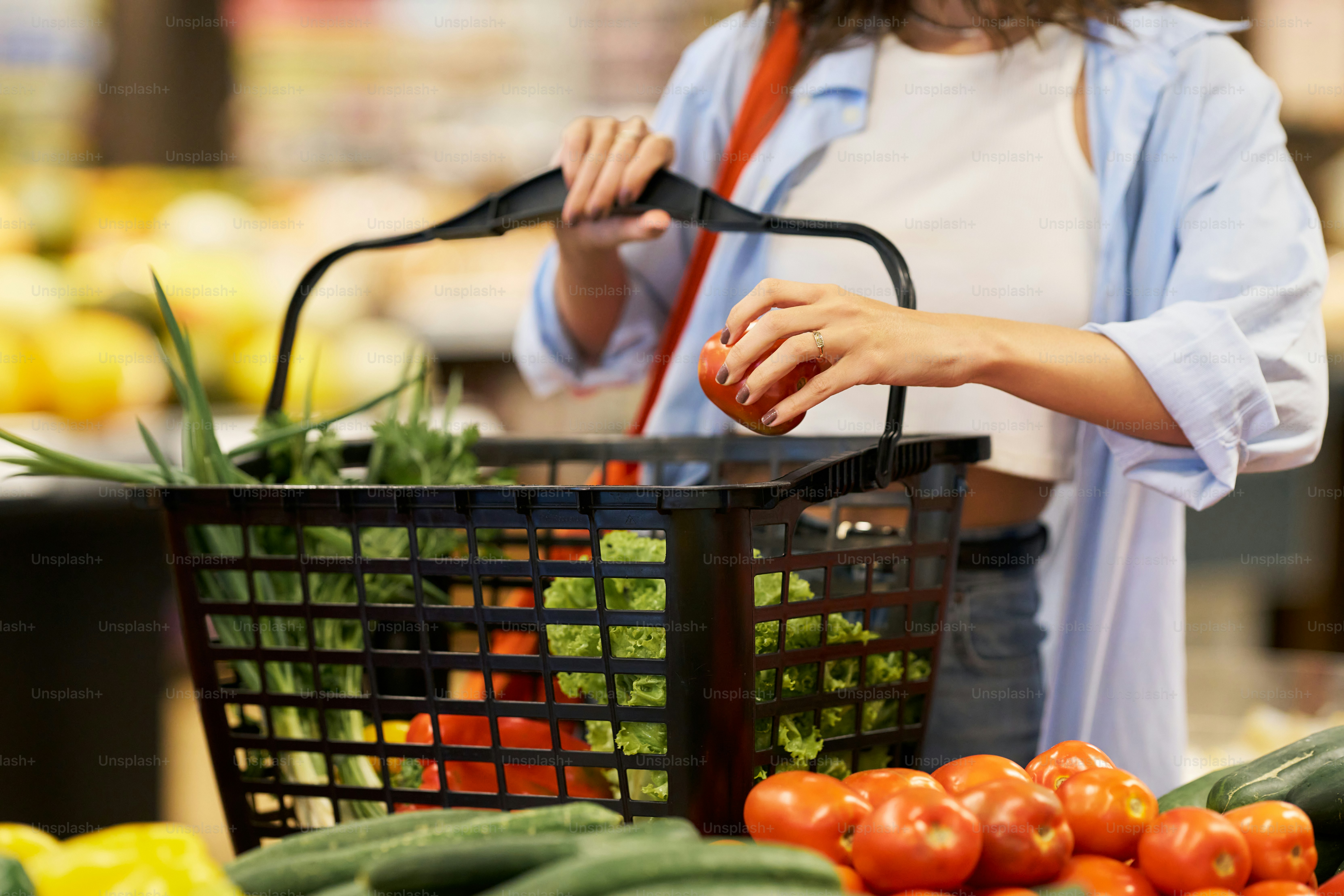 A woman is shopping for groceries at the market. photo – Shopping Image ...