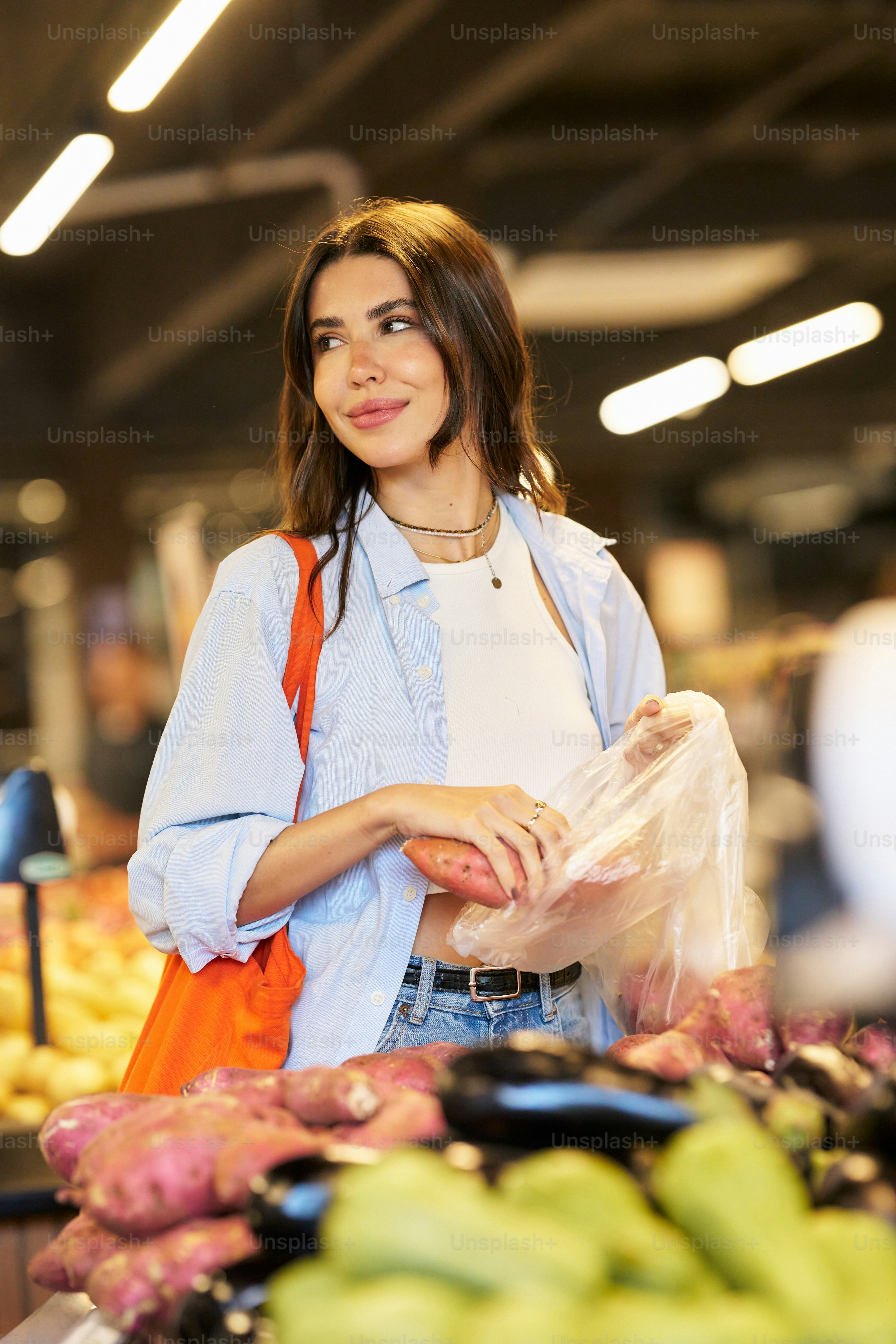 Woman shops for vegetables in a supermarket. photo – Shopping Image on ...