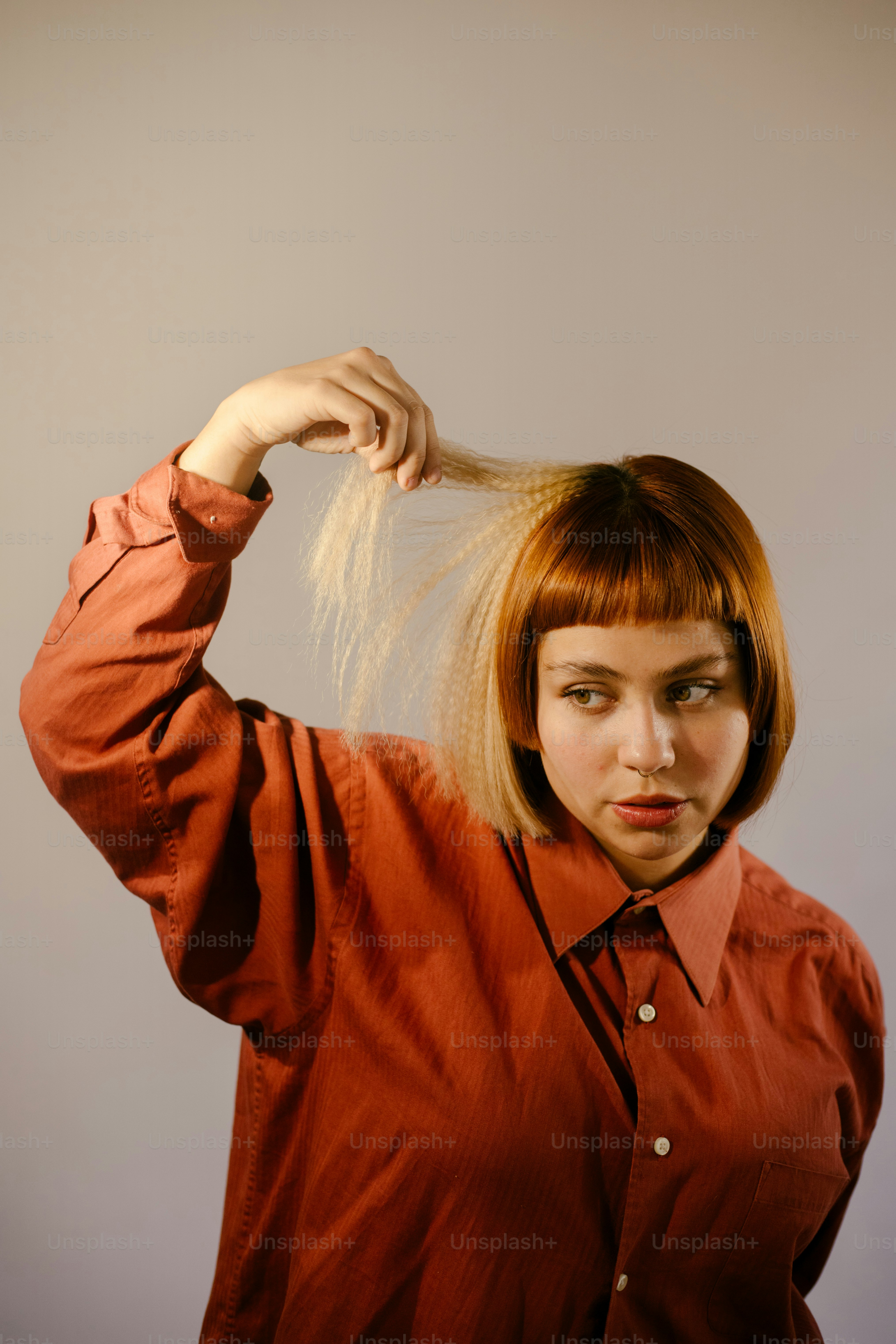 Woman with bold hair looks at her own hair. photo – Portrait Image on ...