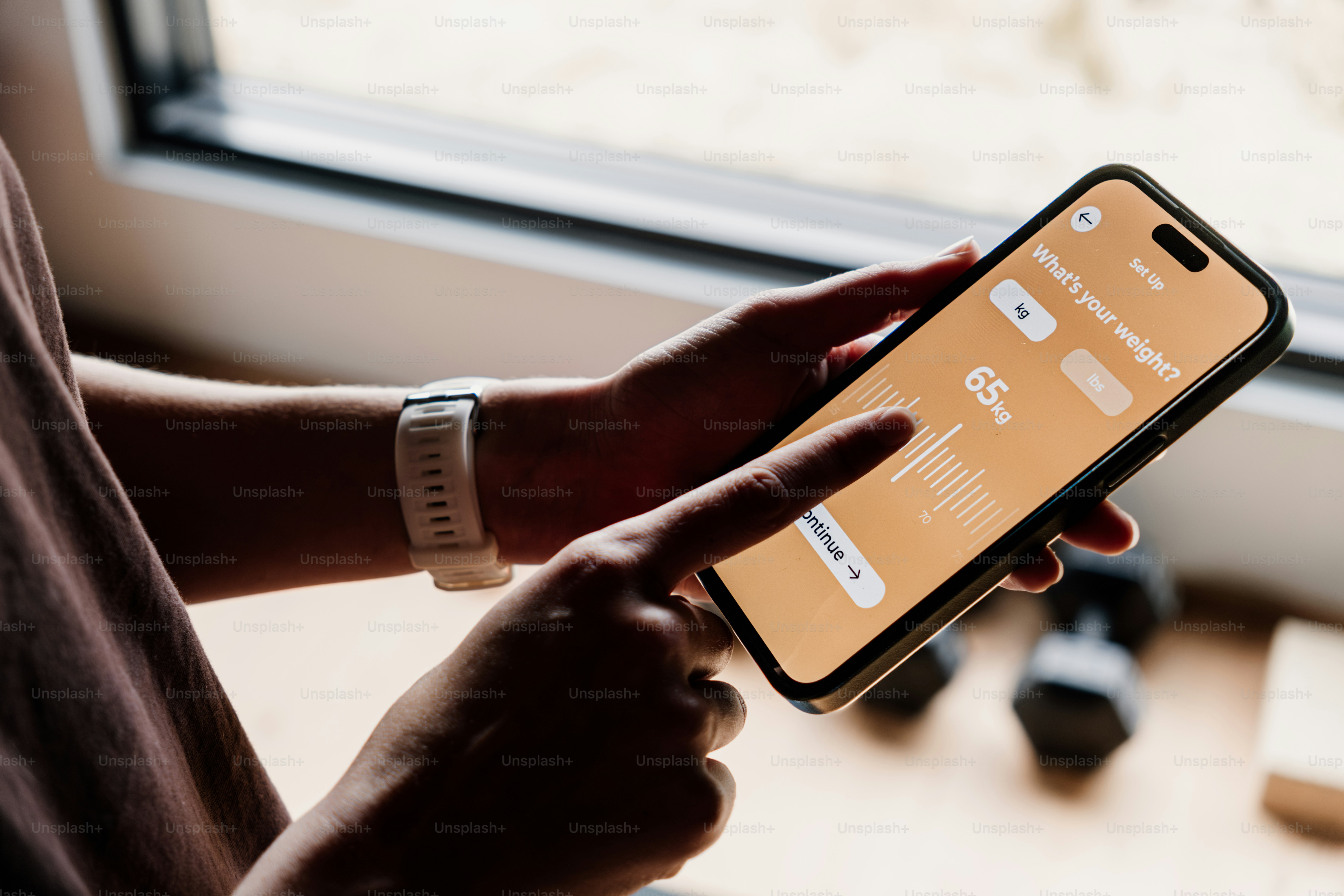 Person uses phone to track their weight. photo – Tech Image on Unsplash