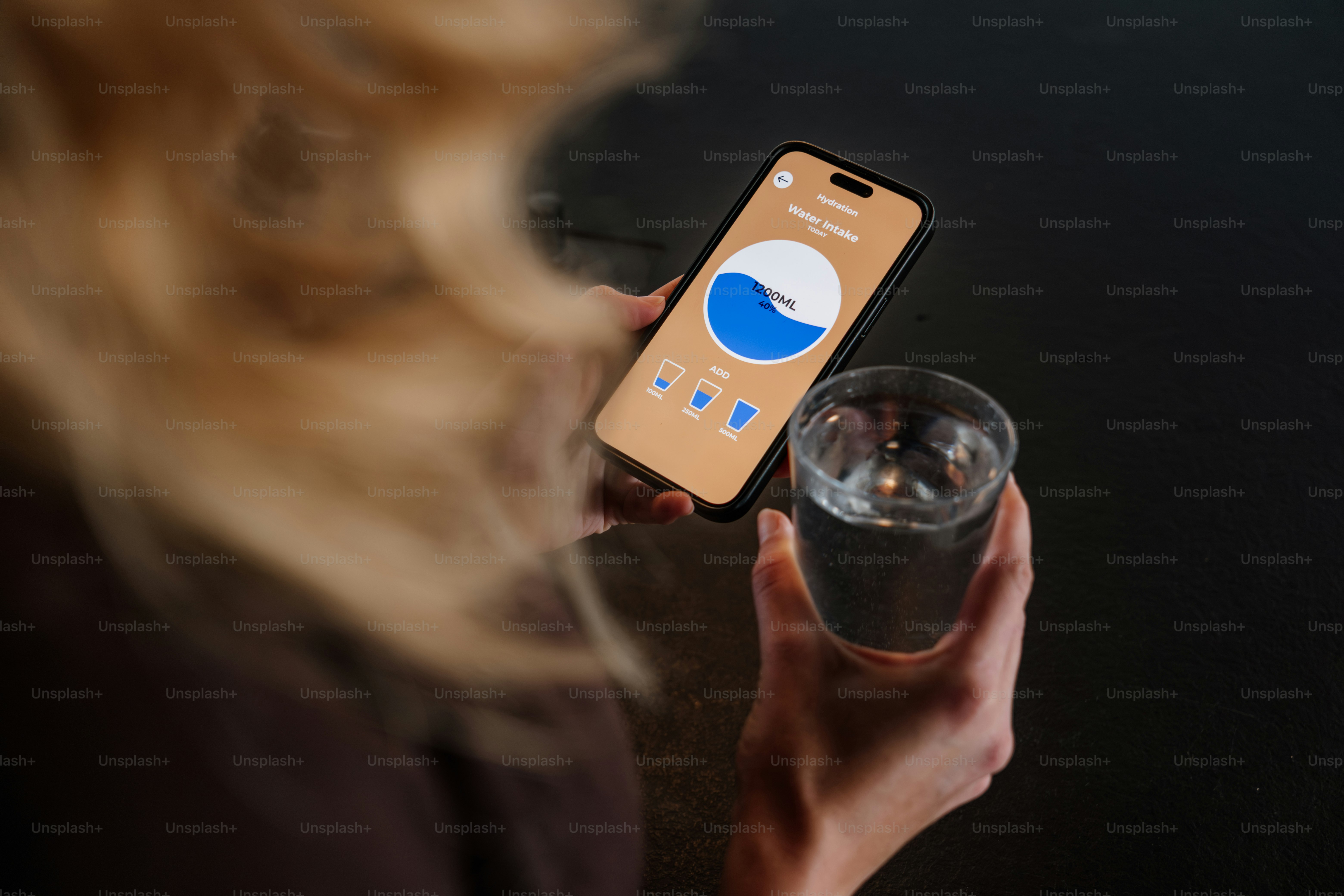 Person using an app to track water intake. photo – Tech Image on Unsplash