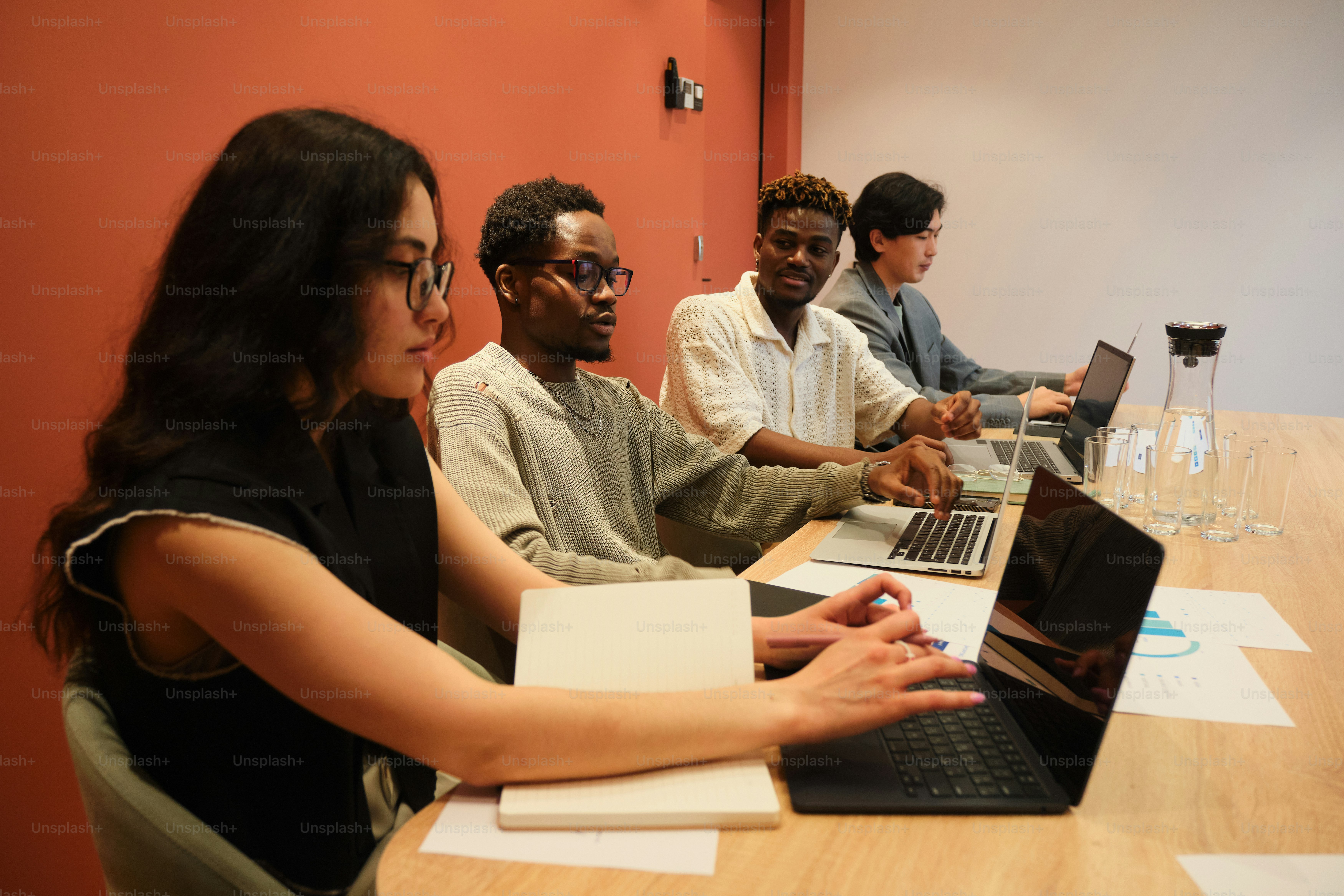 People work on laptops in a modern office. photo – Team Image on Unsplash