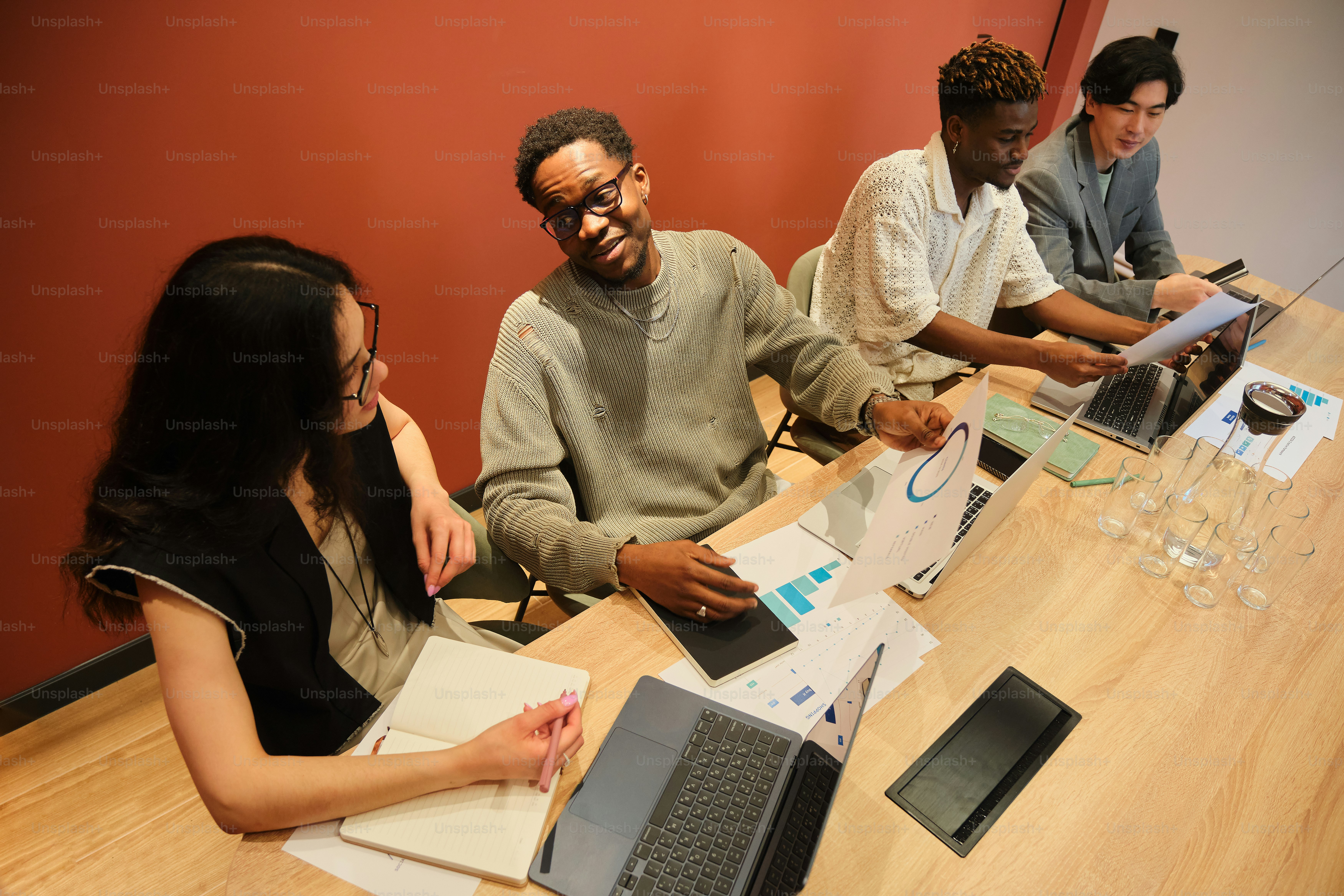 People work on laptops in a modern office. photo – Team Image on Unsplash
