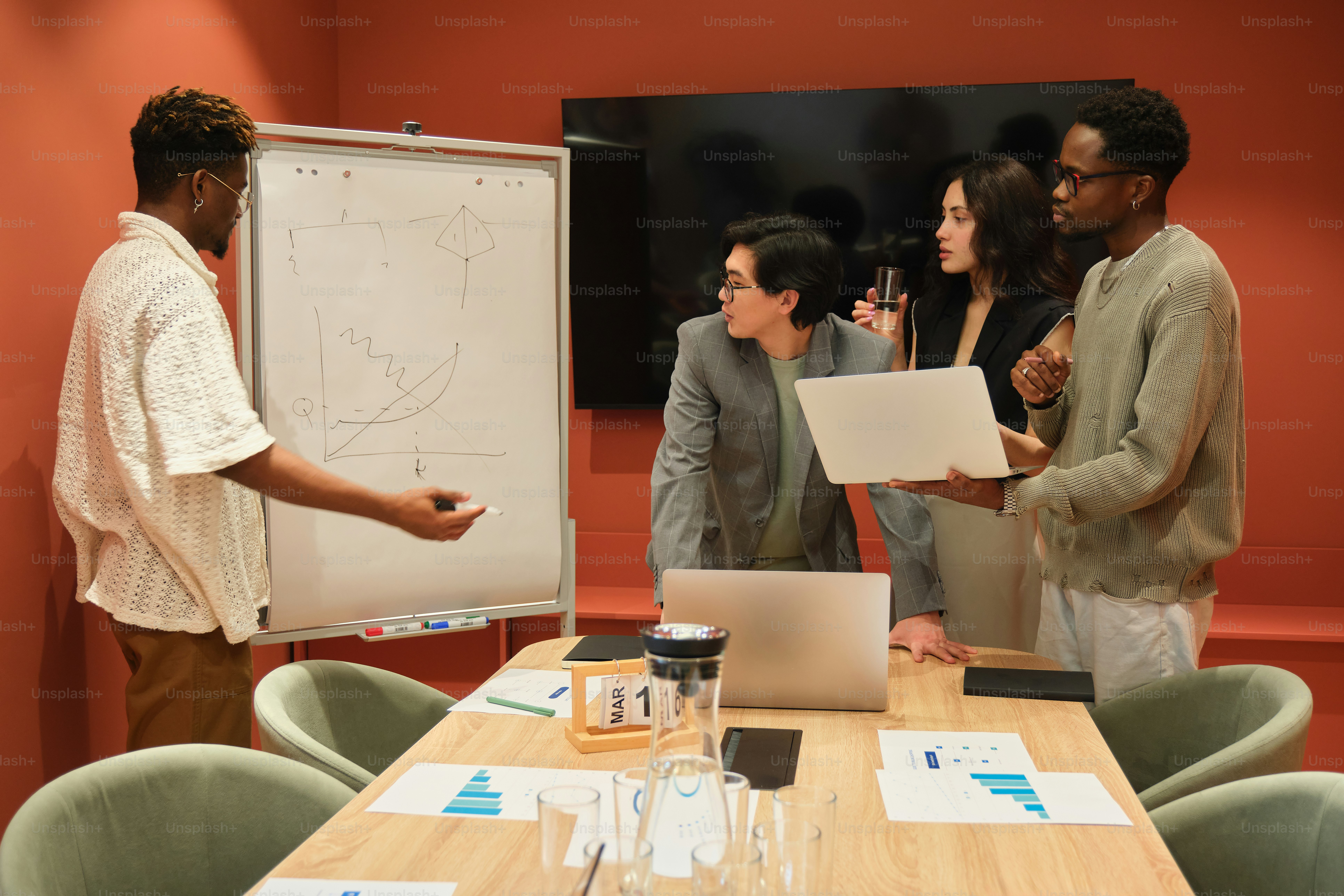 Team members are collaborating and working together at their desks ...