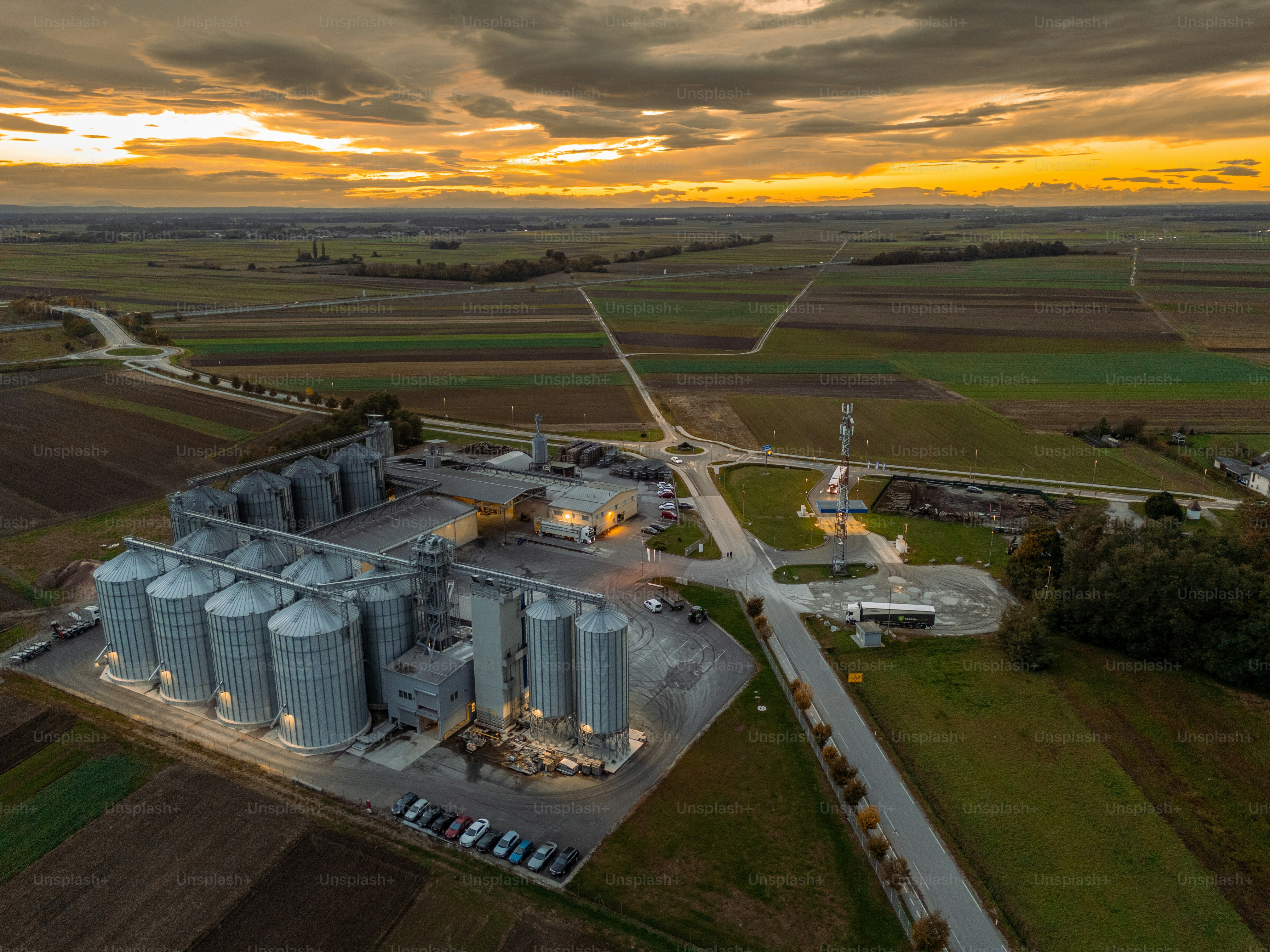 Aerial view captures a large silo towering over surrounding fields ...