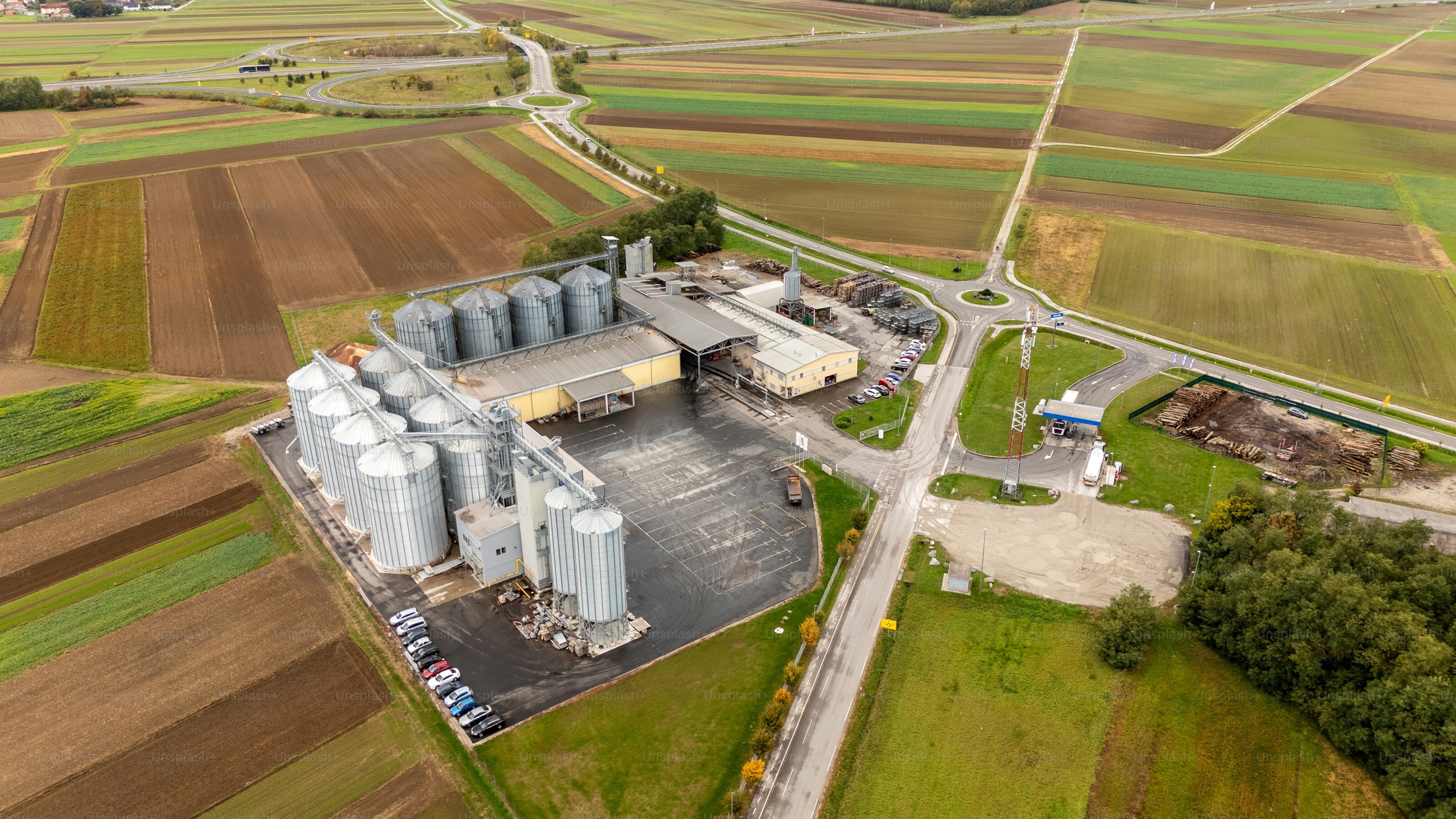 An aerial view highlights a large silo with multiple storage units ...