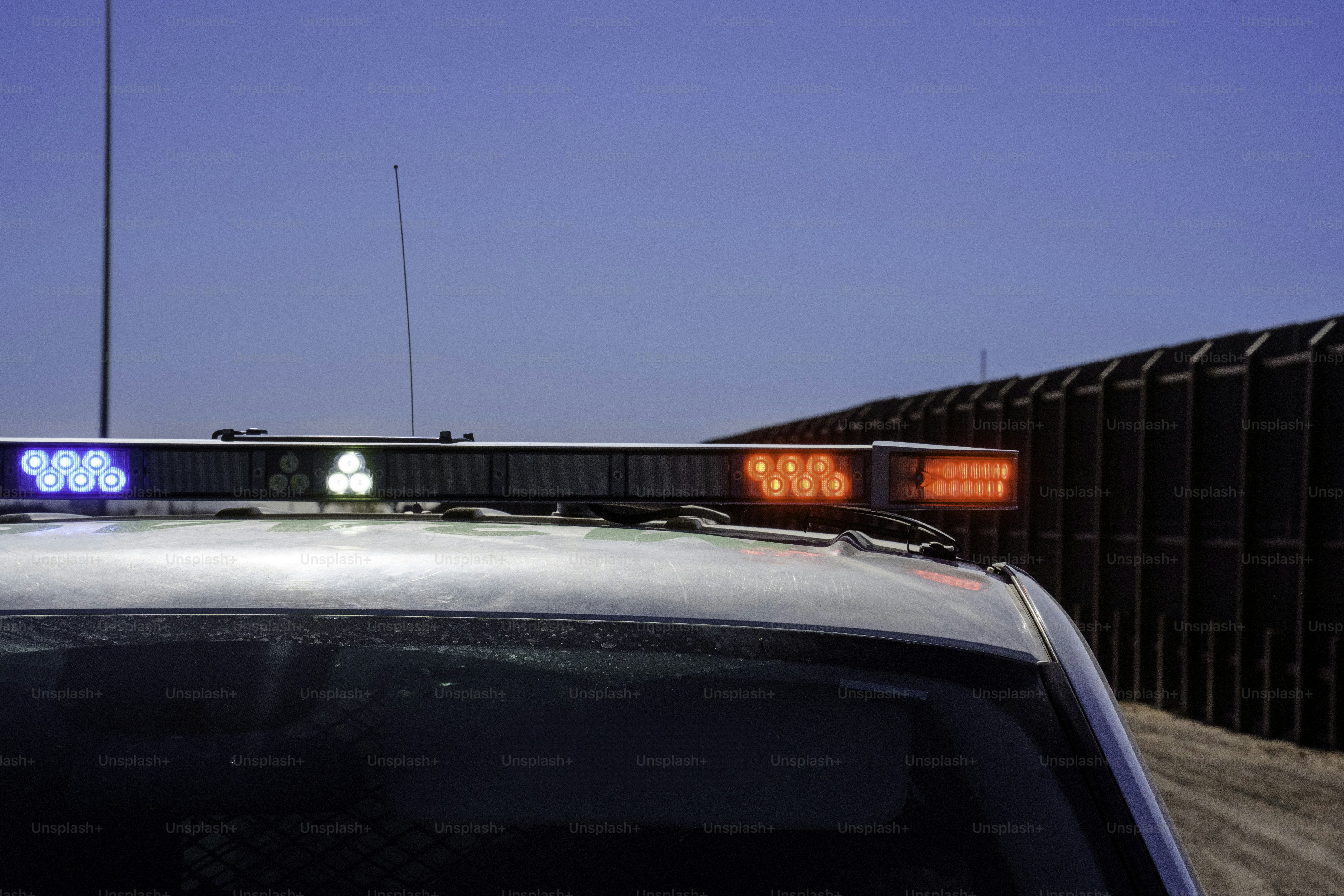 Border Patrol Vehicle with Police Lights On Sitting in Front of Border ...