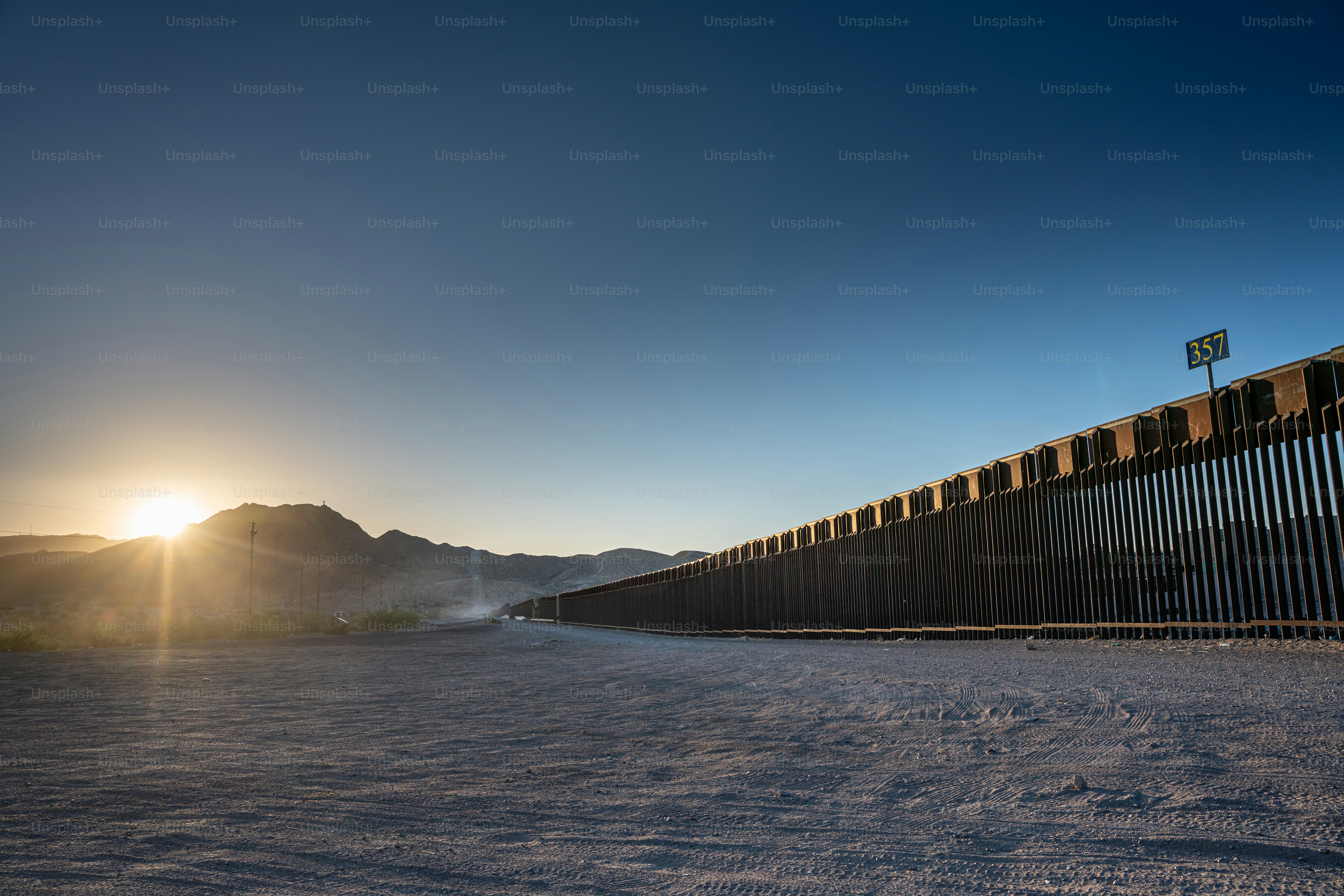 The American Border Wall Near Mexico with the Sun Peaking Out Over ...