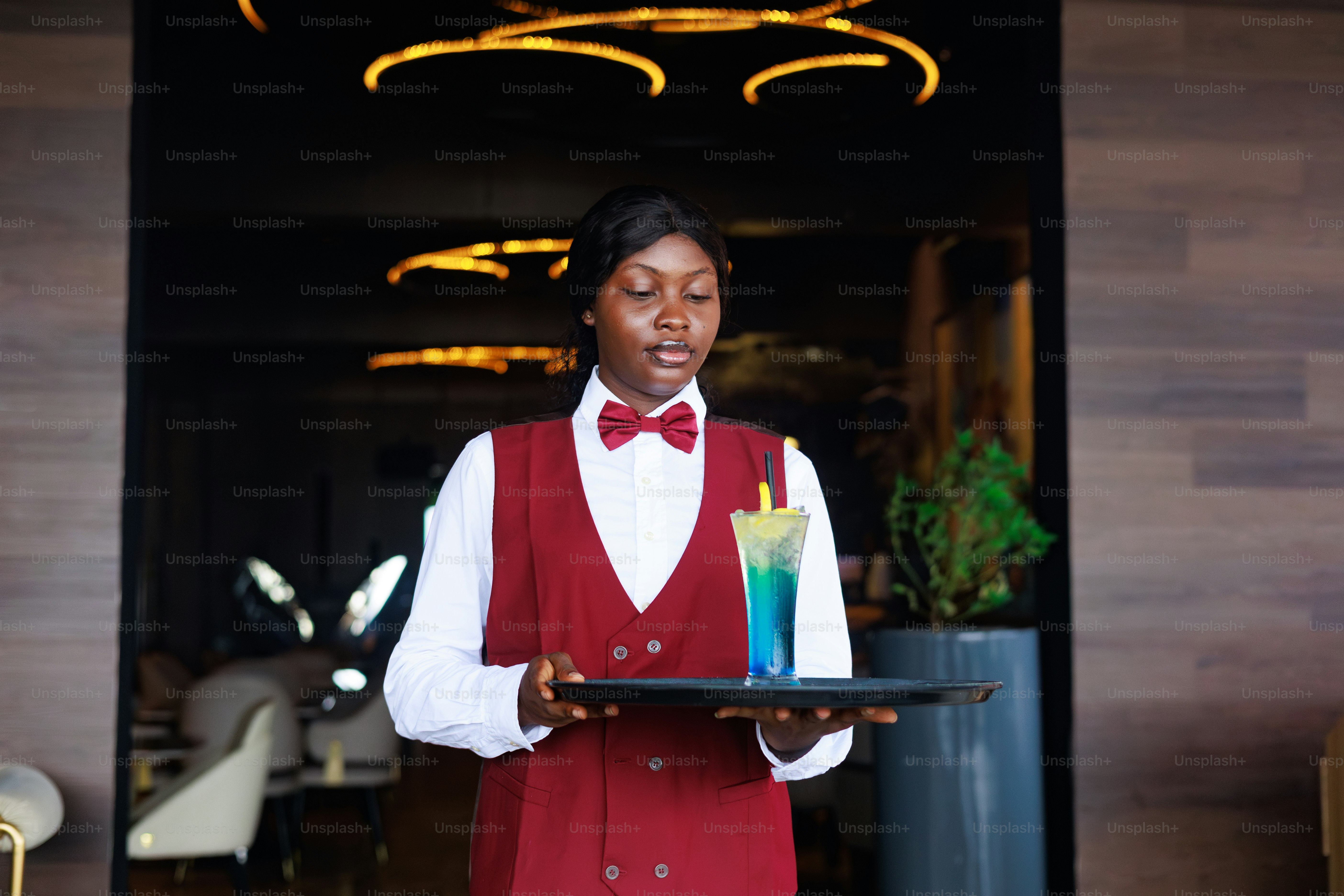 Waitress serves a colorful cocktail on a tray. photo – Restaurant Image ...