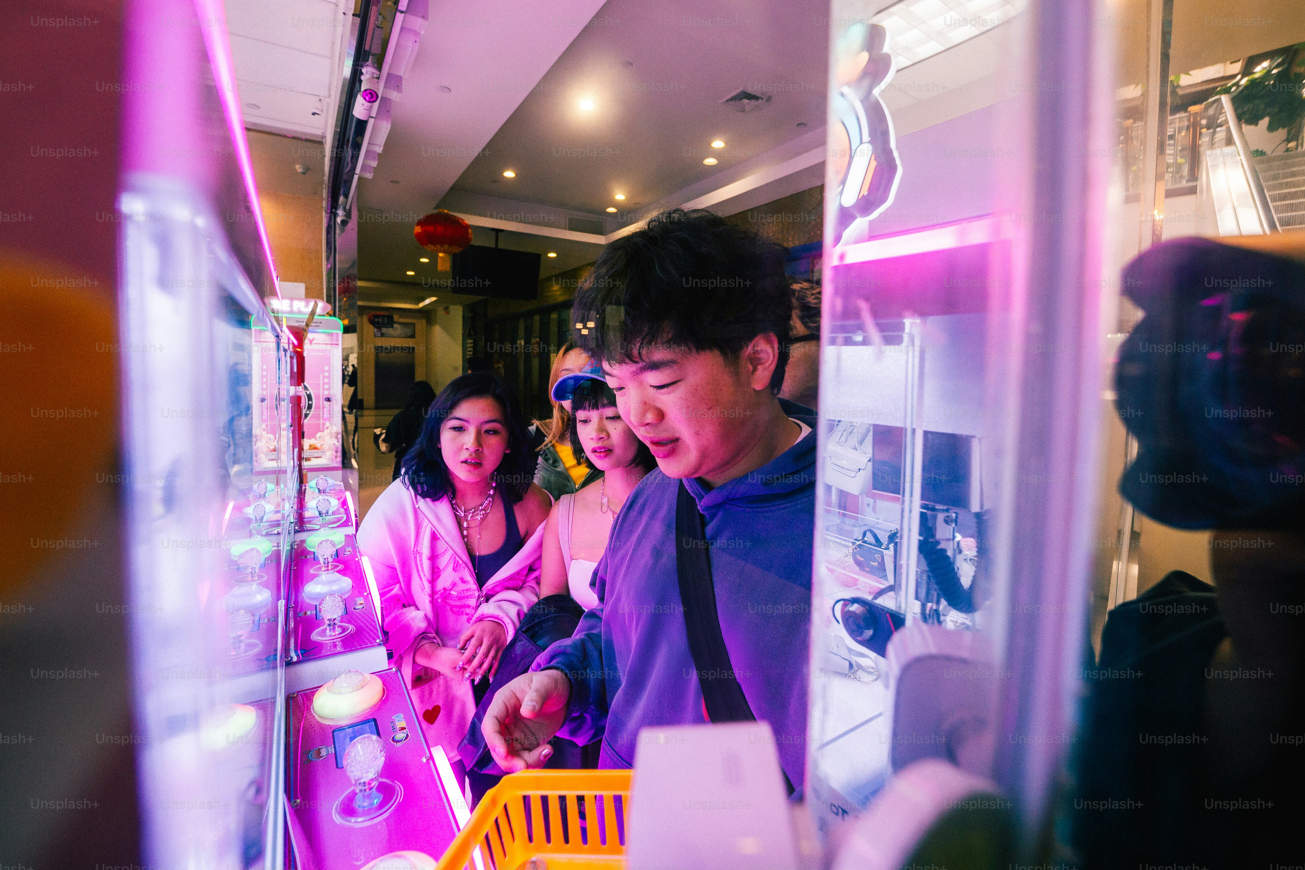 People browse a vending machine with colorful lights. photo – New york ...