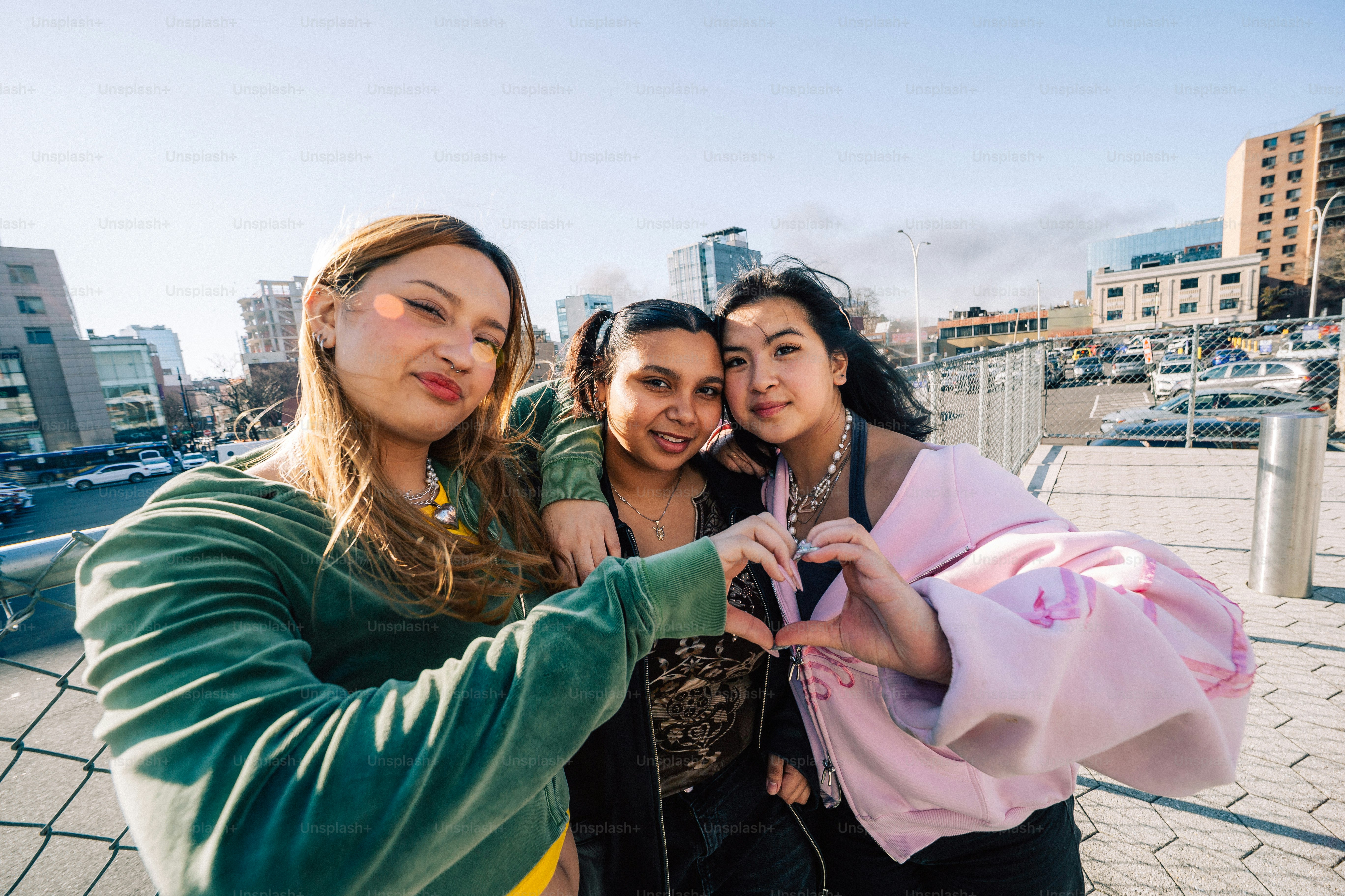 Three friends pose and show love. photo – New york Image on Unsplash