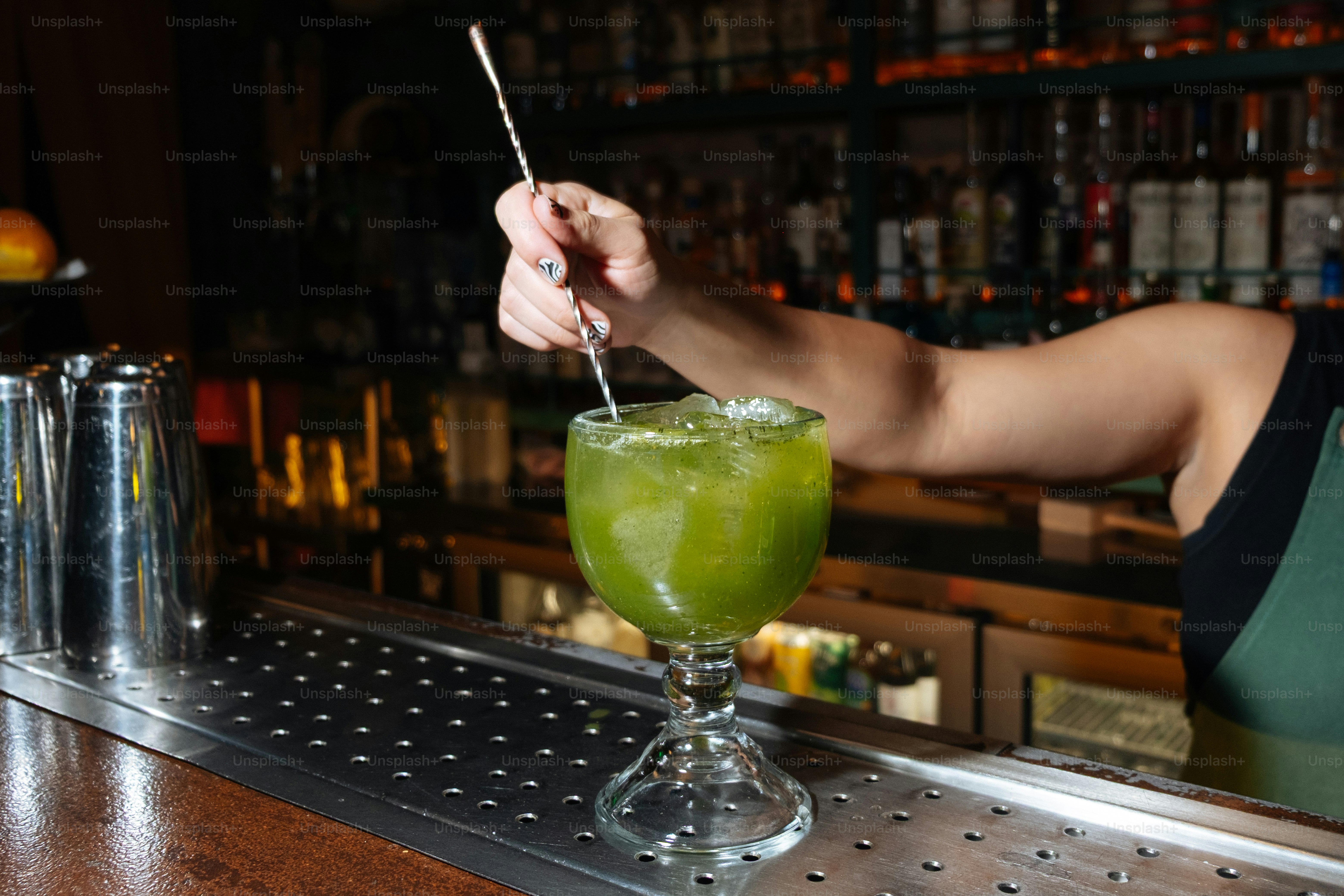 Bartender pouring a green liquid into a shaker. photo – Bar Image on ...