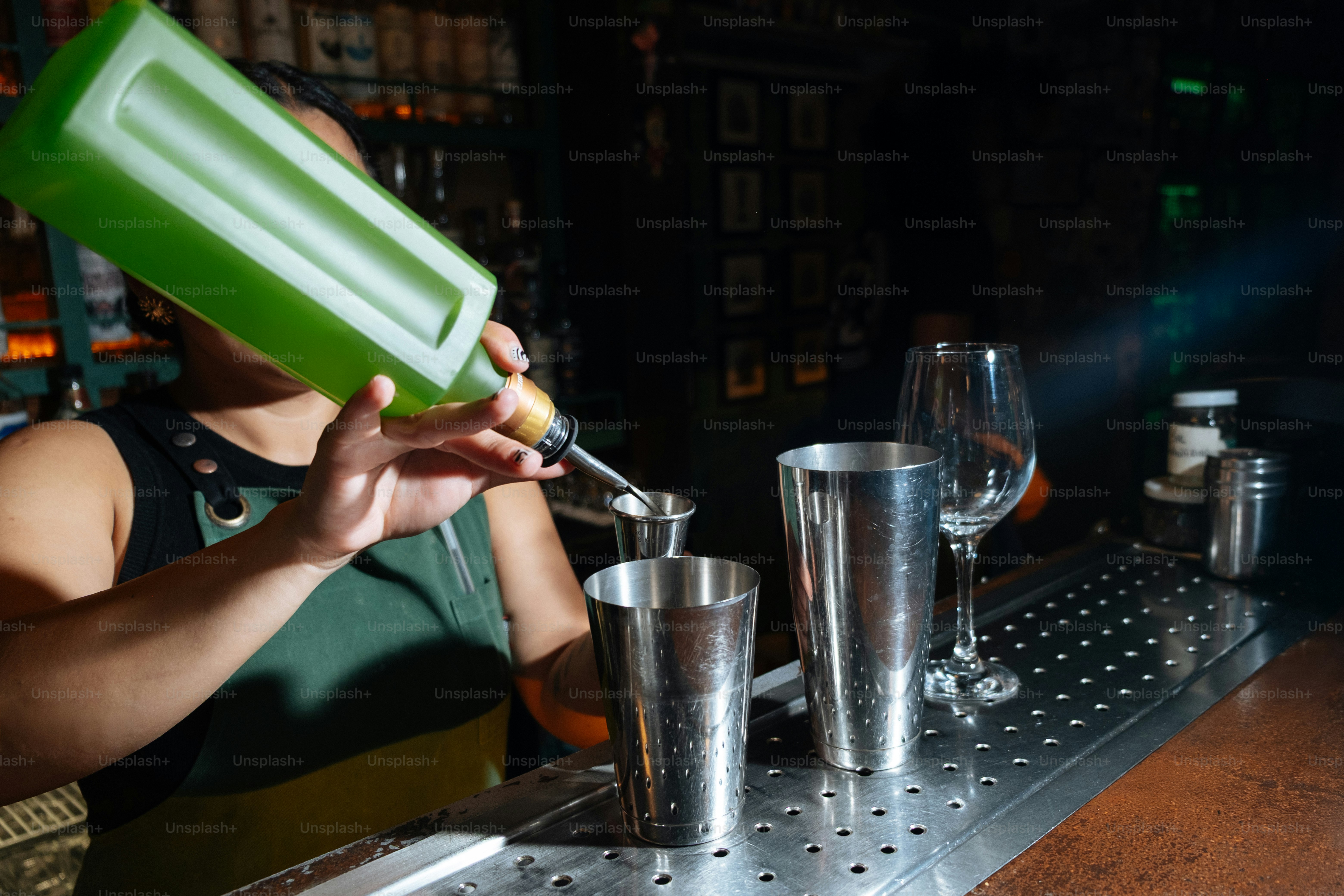 Bartender pouring a green liquid into a shaker. photo – Bar Image on ...
