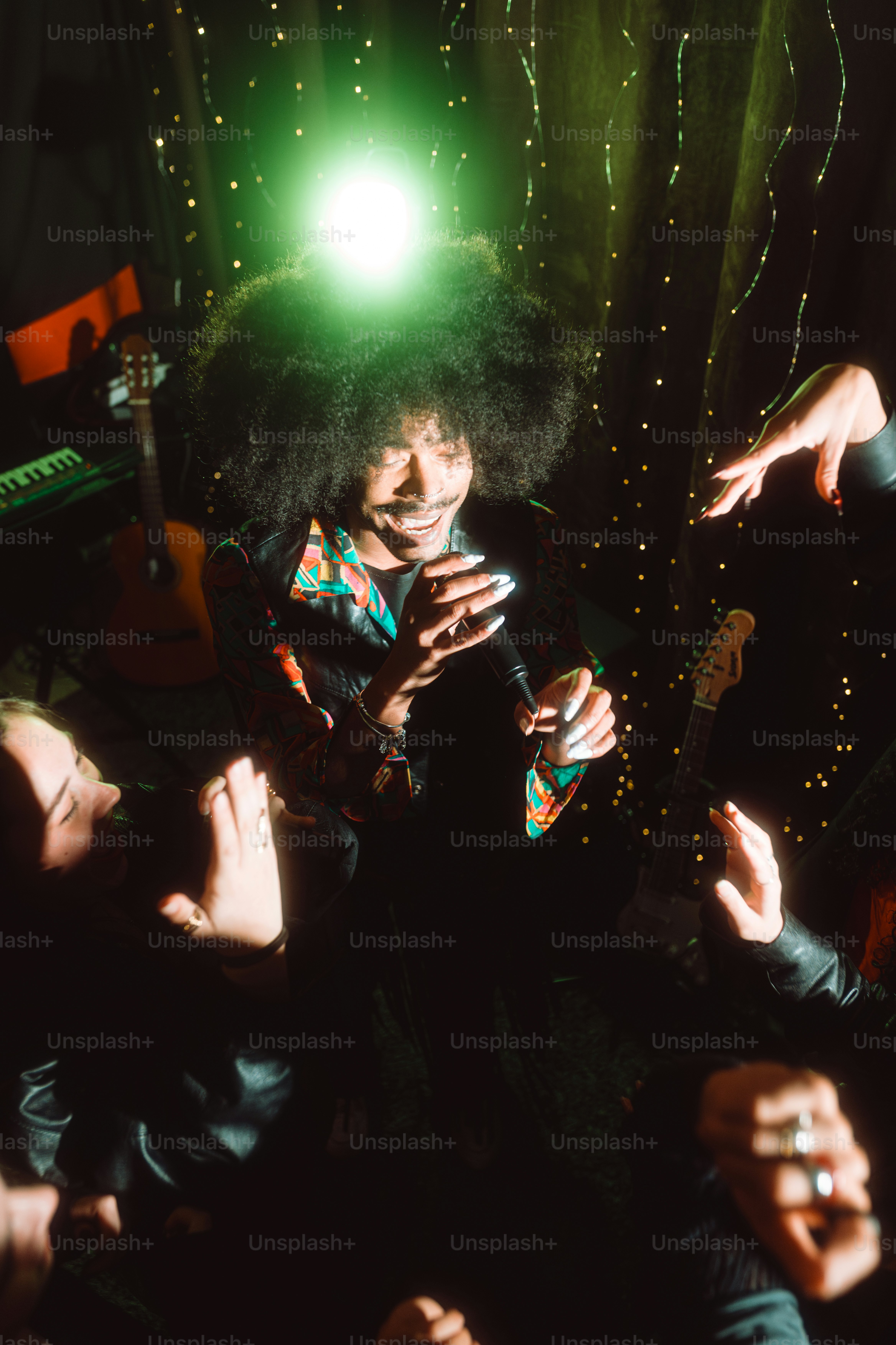 Singer performs on stage, surrounded by fans. photo – Music Image on ...