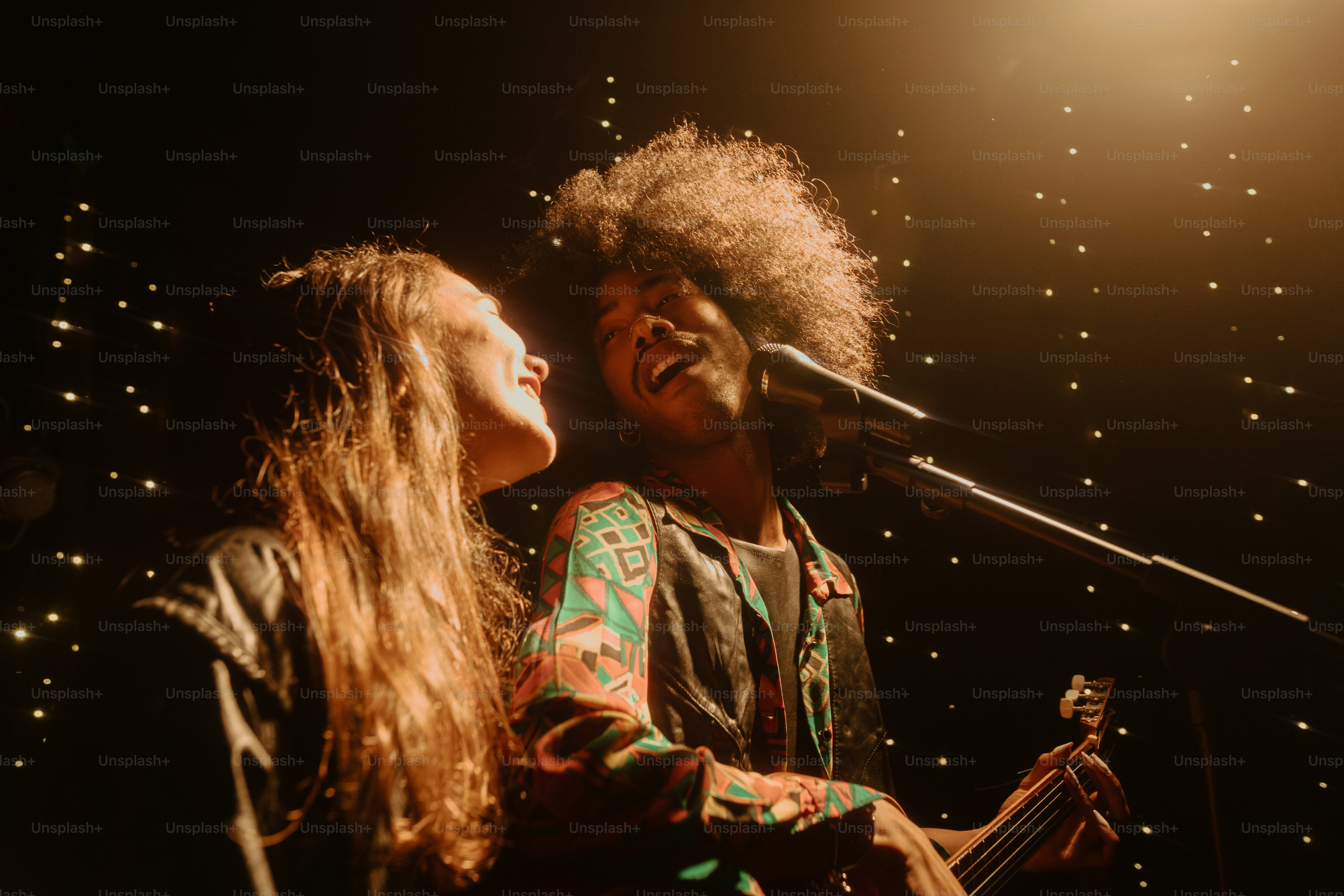 Two musicians sing together on stage. photo – Music Image on Unsplash