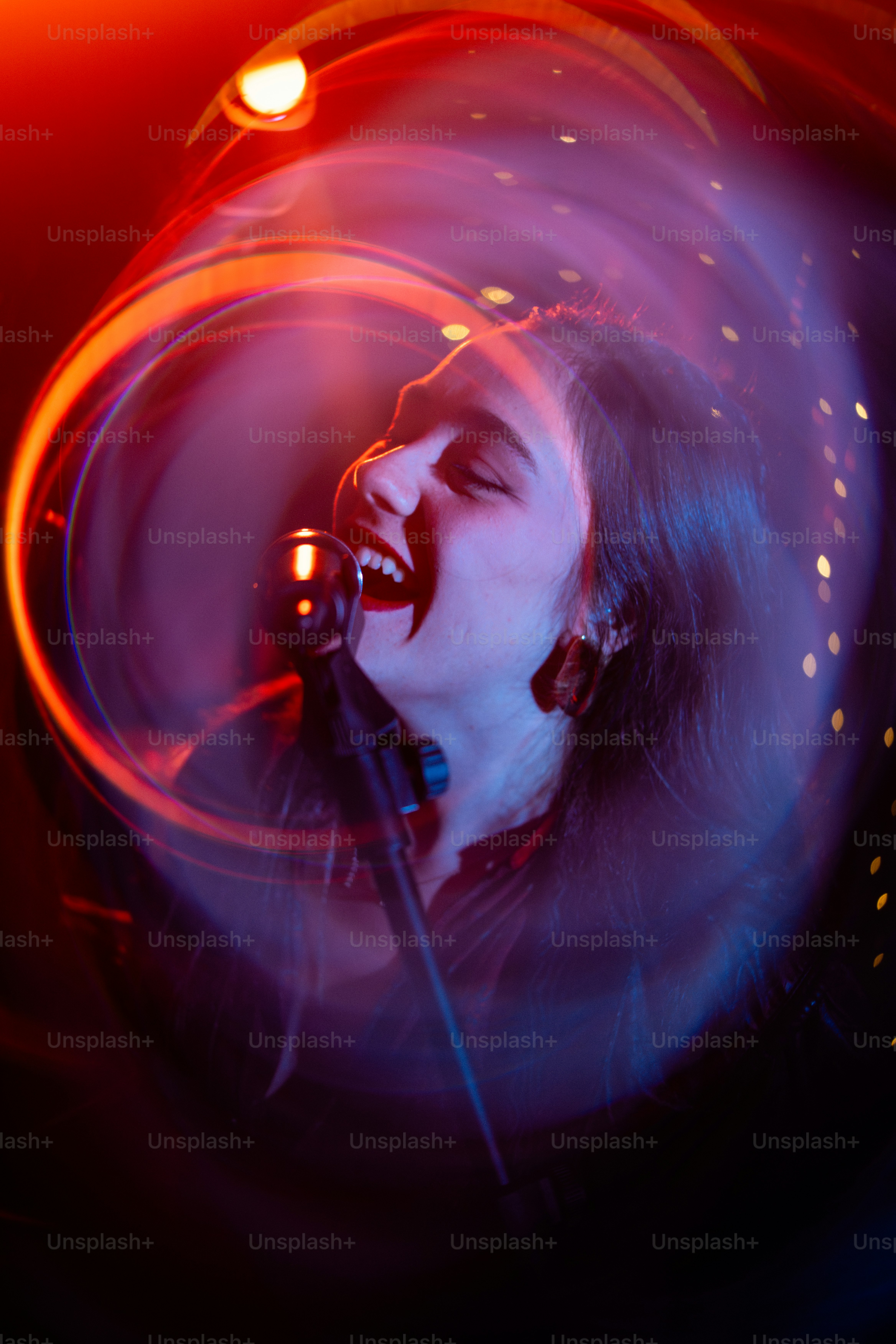 Singer is passionately performing in a colorful light. photo – Music ...