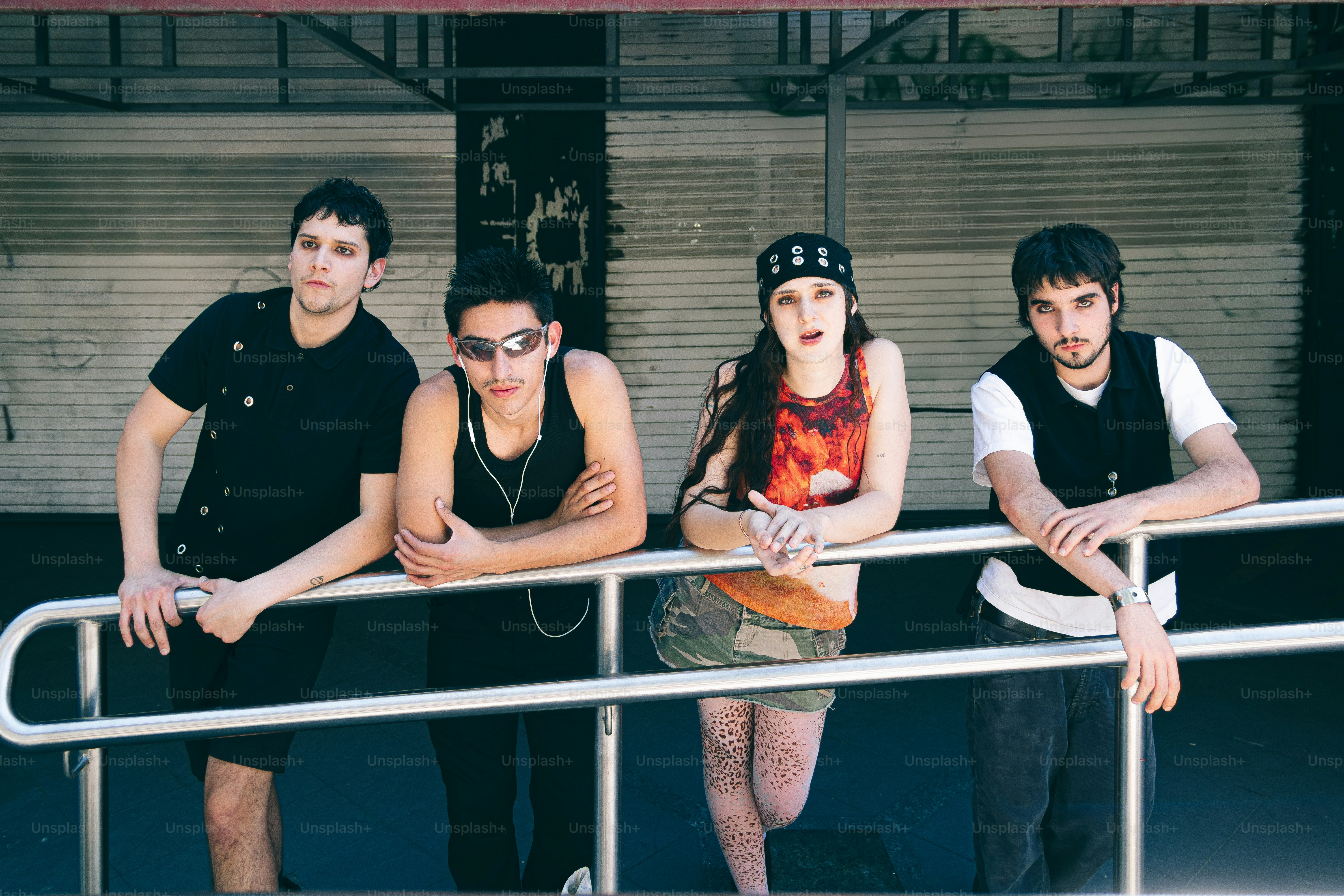 A band poses in front of a metallic wall. photo – Diversity Image on ...