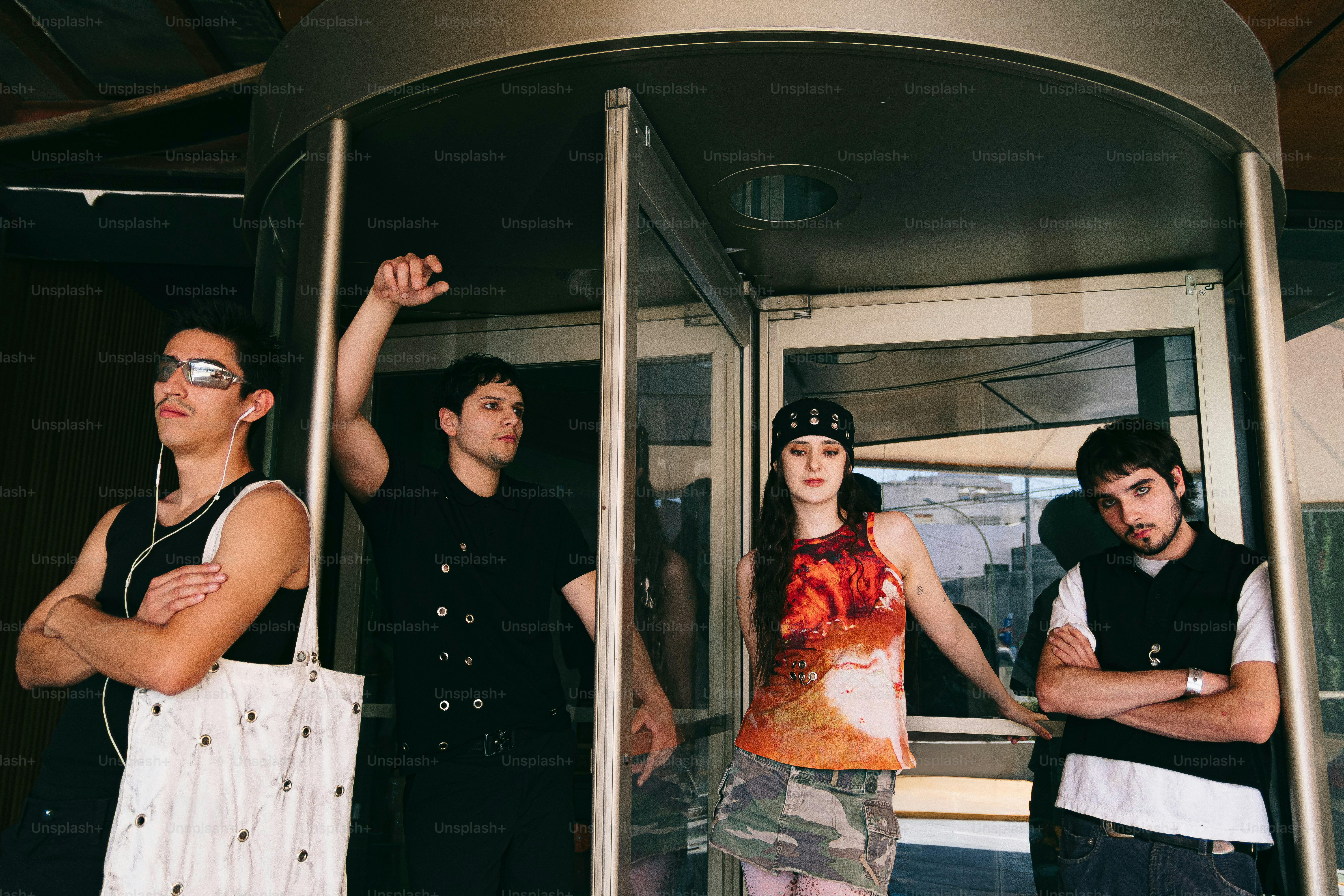 Four people pose at a revolving door. photo – Diversity Image on Unsplash