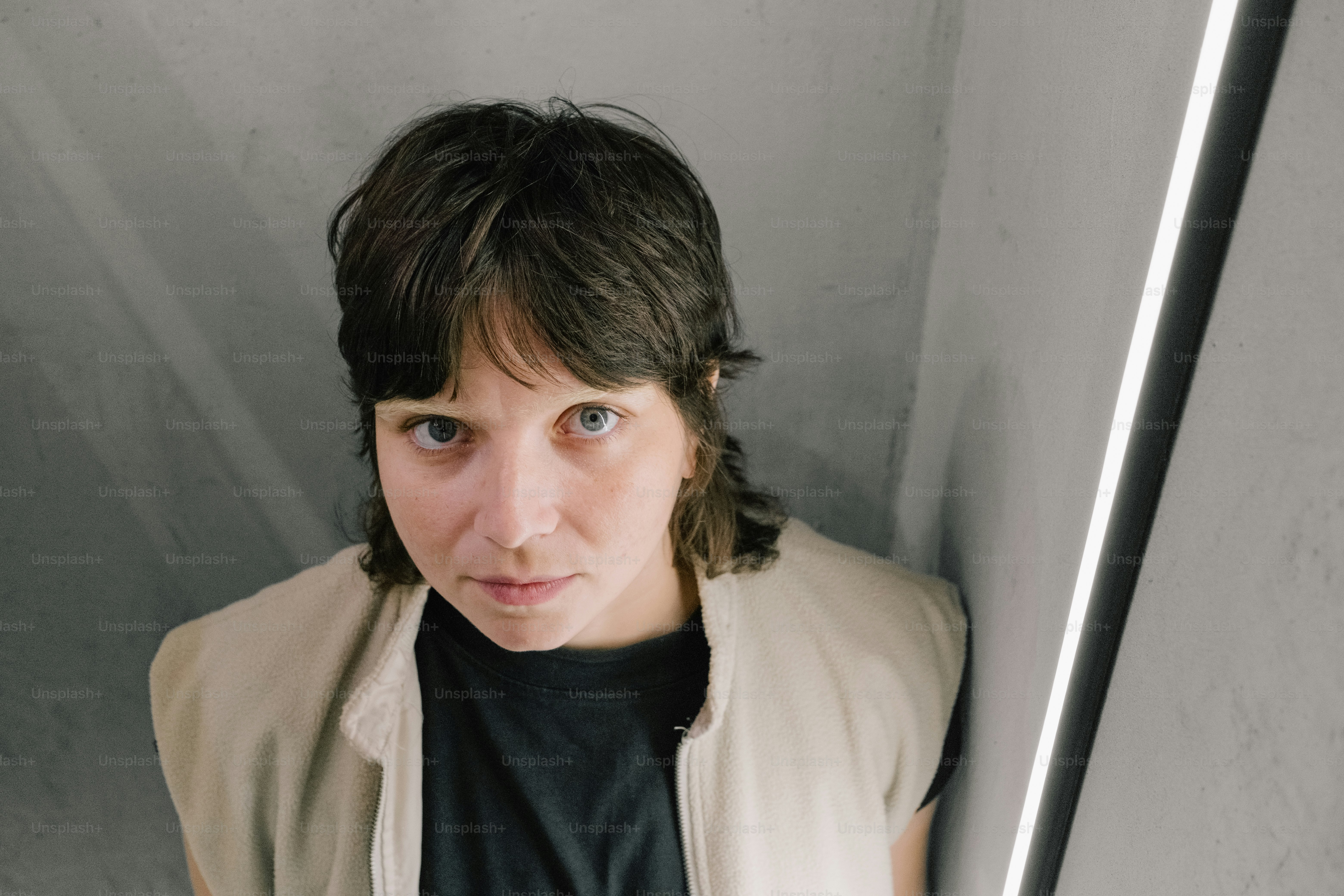 Woman stares directly at the camera with stern eyes. photo – Portrait ...