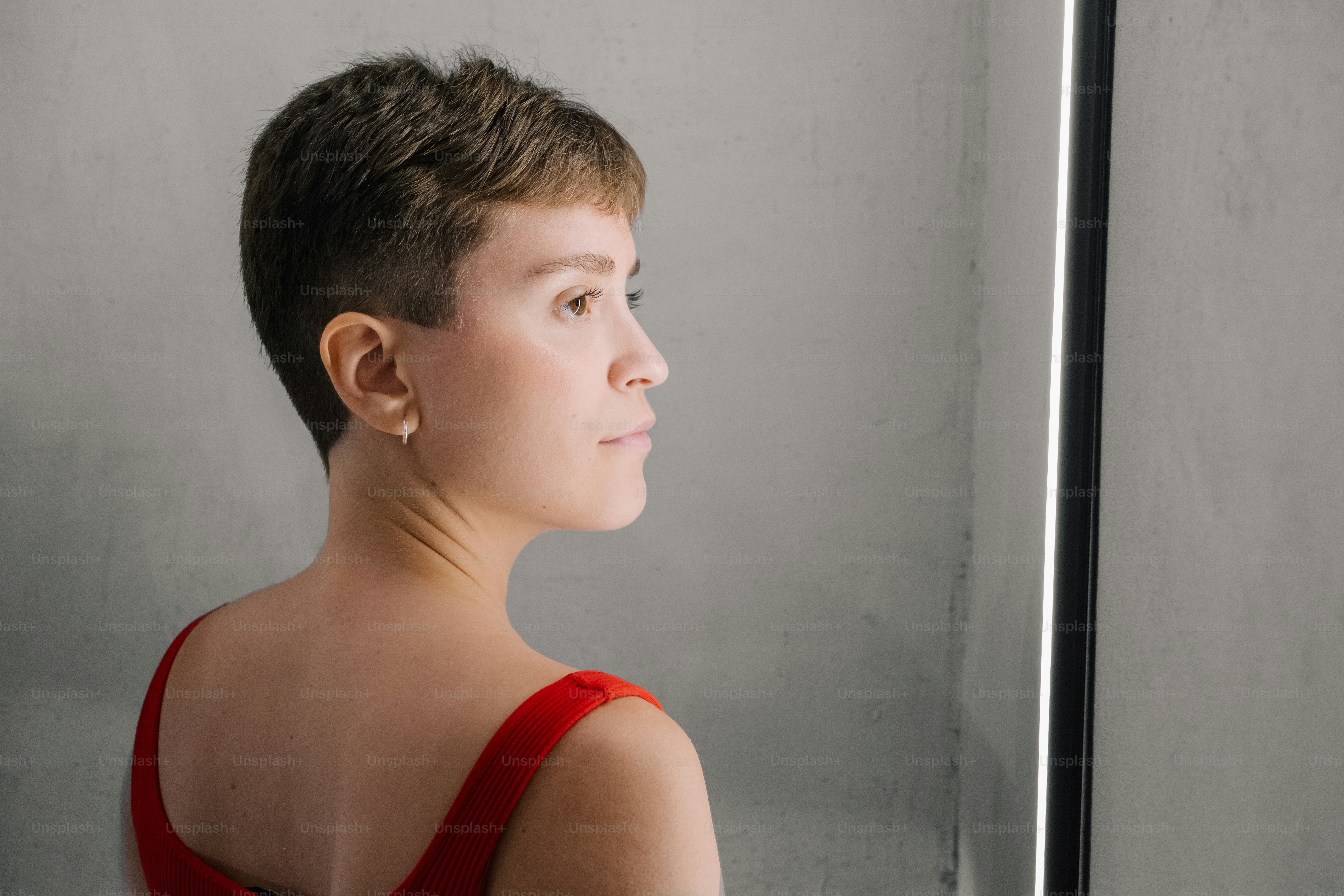 Una mujer mira de reojo frente a un espejo. foto – Imagen de Retrato en ...