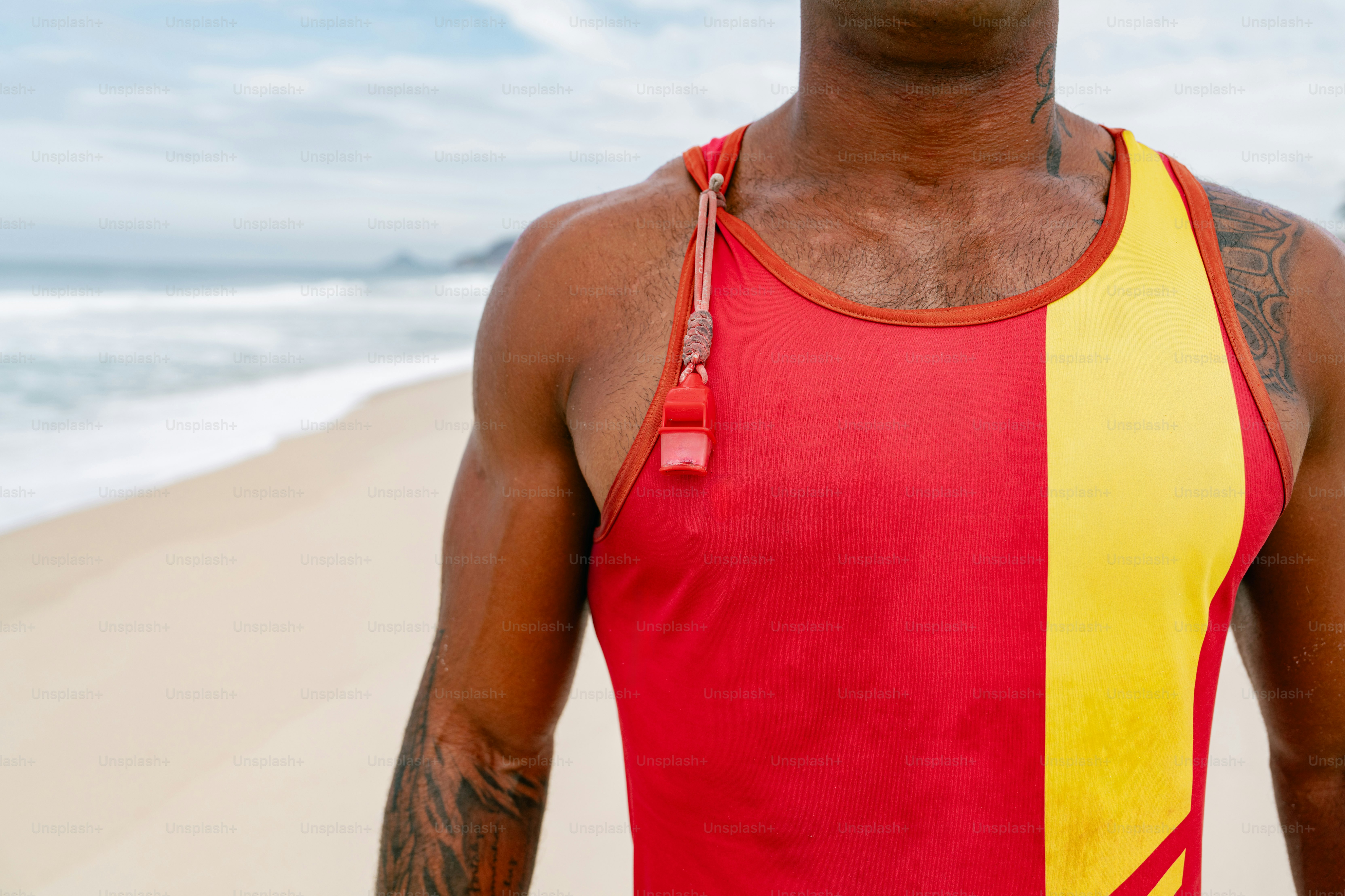 A lifeguard stands ready on the beach. photo – Beach Image on Unsplash
