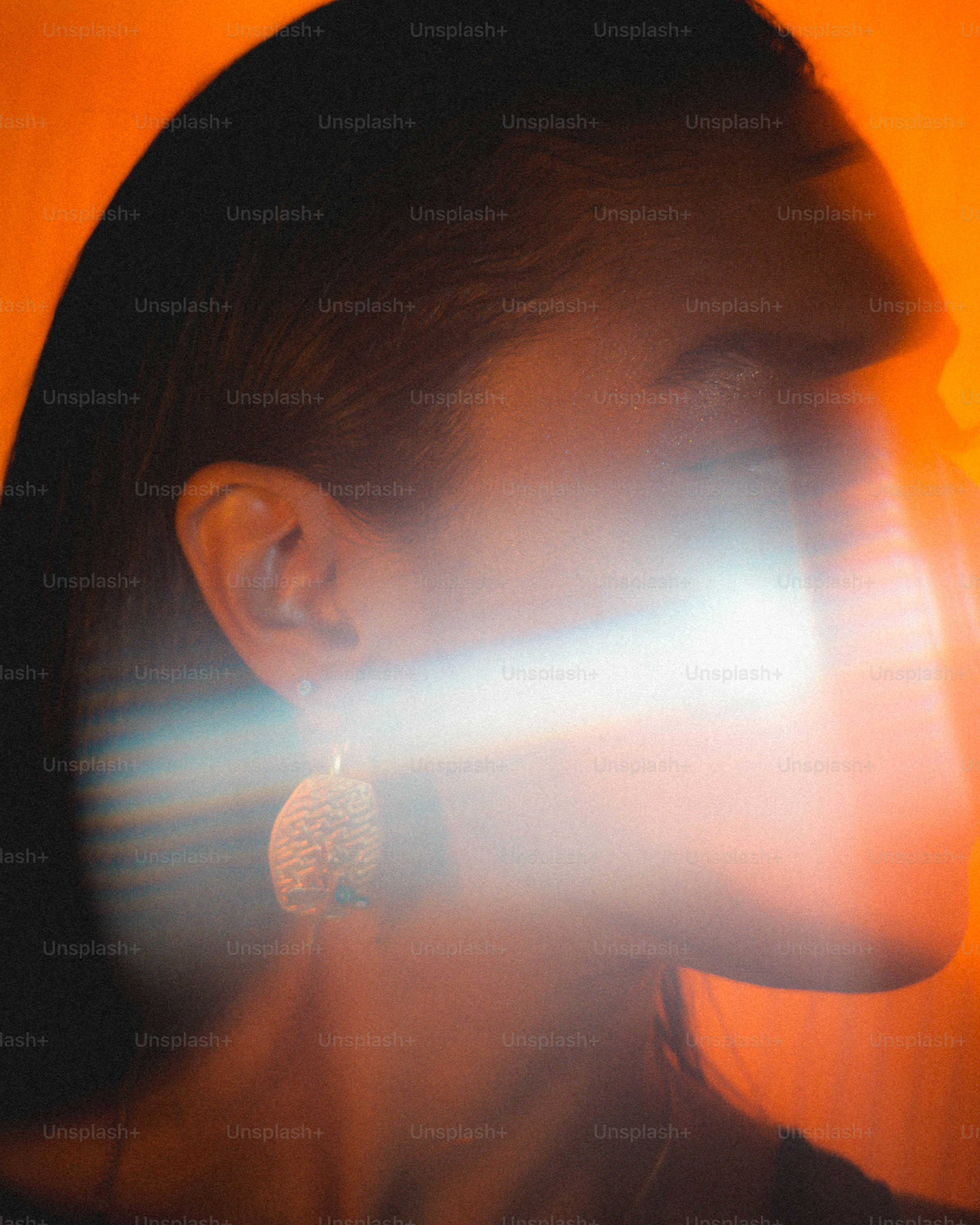 A woman's face is partially lit by bright light. photo – Woman Image on ...