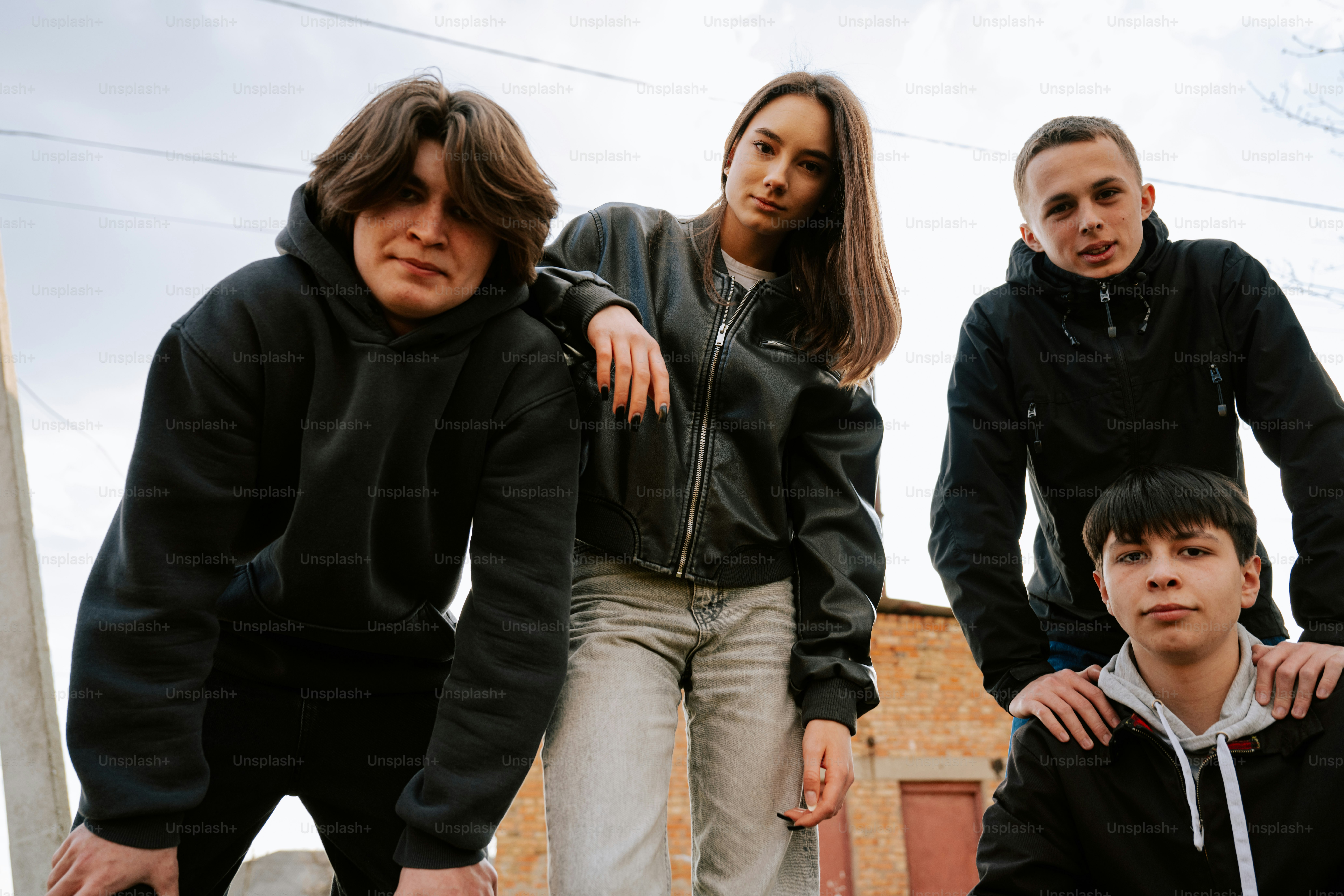 A group of friends hangs out outdoors together. photo – Diversity Image ...
