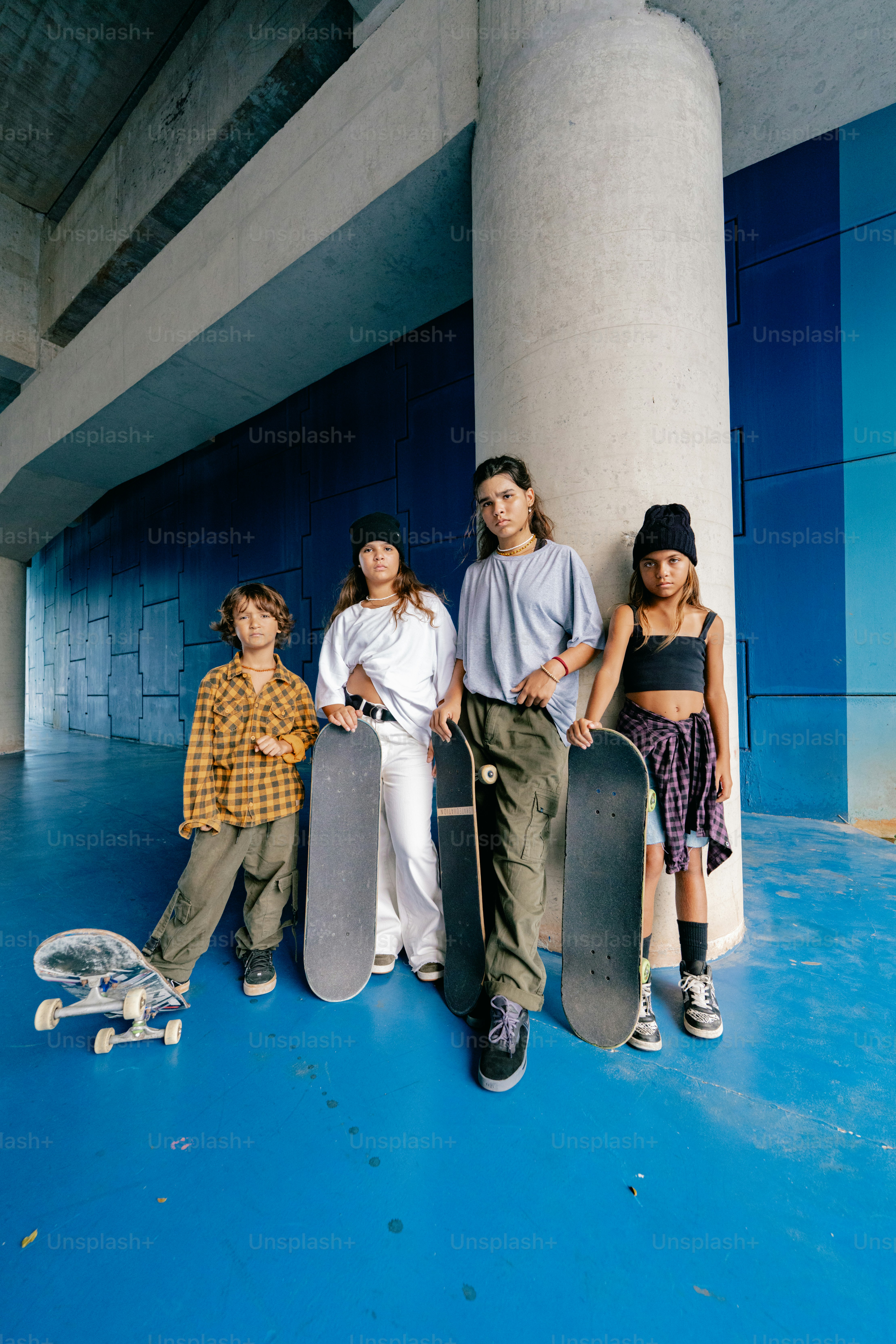 Four skateboarders pose for a photo together. photo – Urban Image on ...