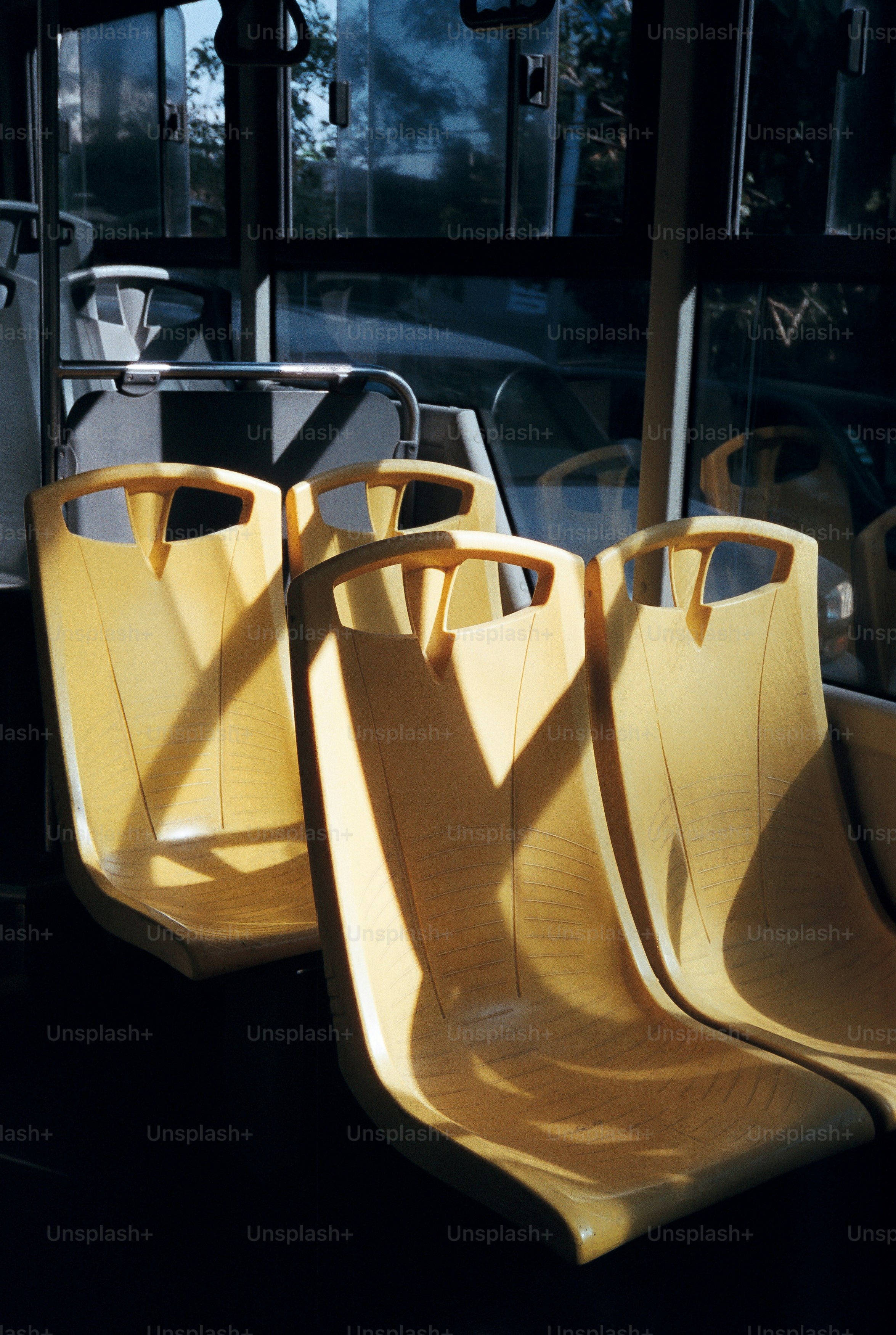 Yellow seats on a bus are illuminated by the sun. photo – Photography ...