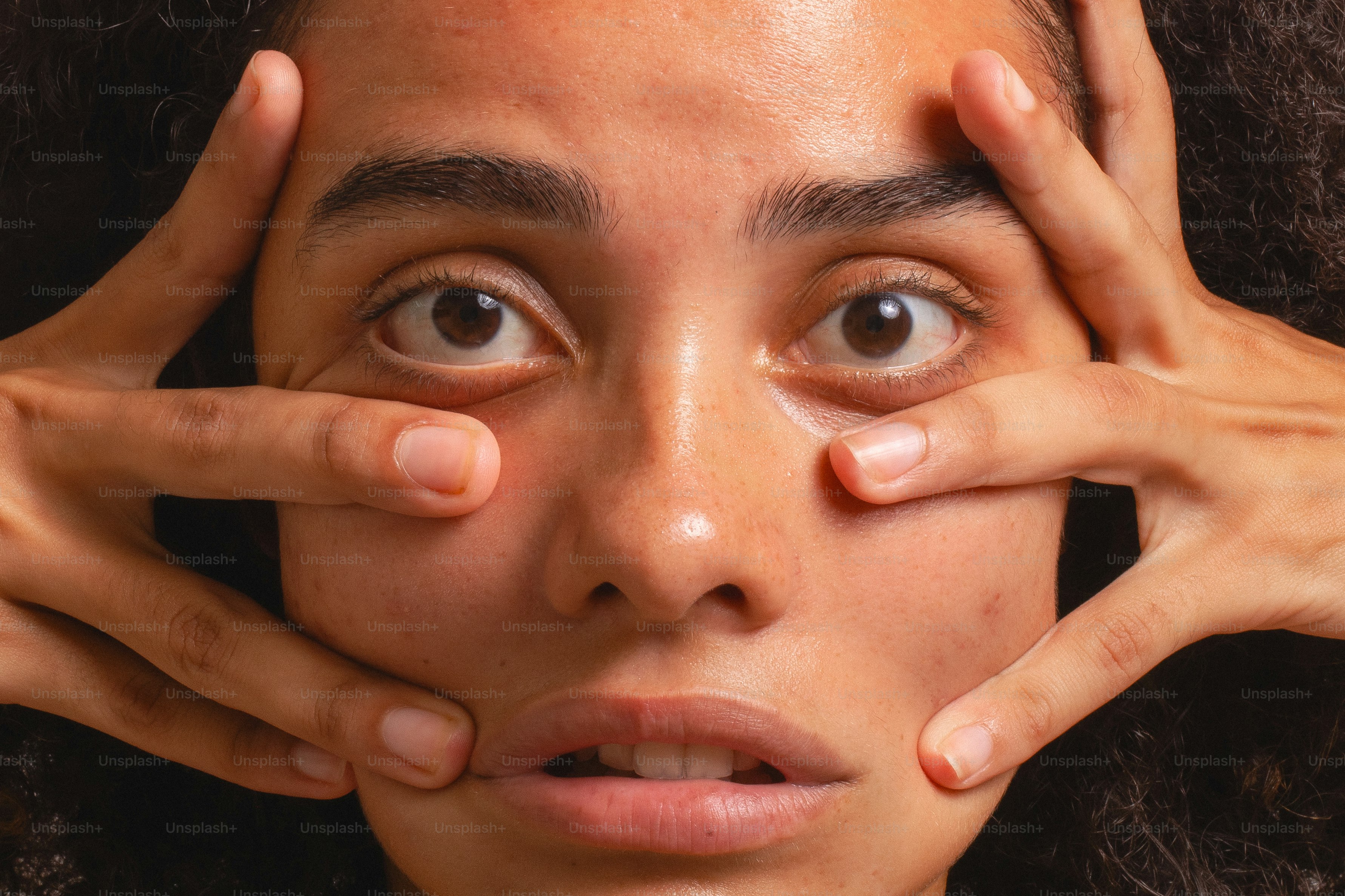 Woman's face with hands framing her eyes. photo – Portrait Image on ...
