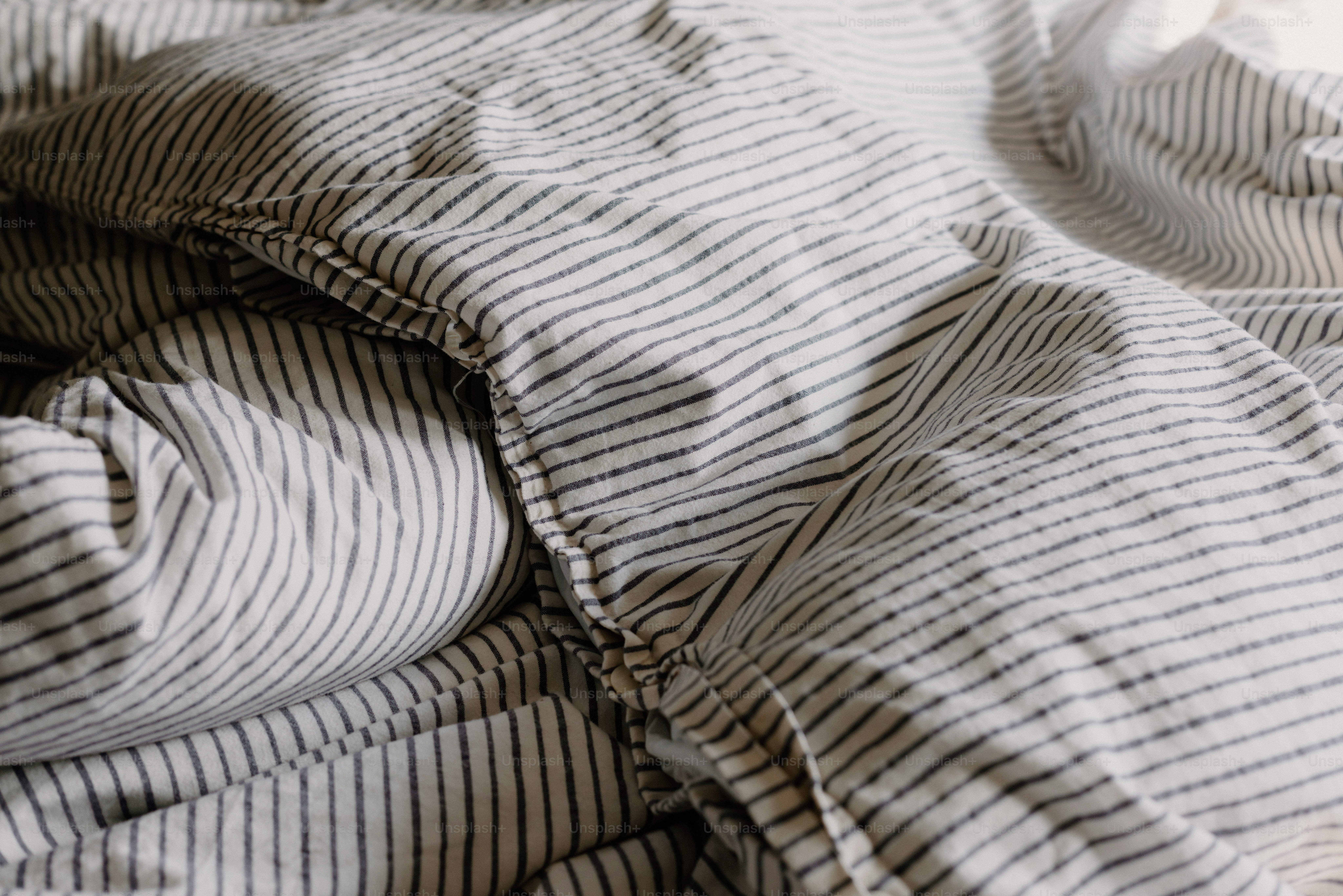 Striped bedding, crumpled and relaxed. photo – Cosy Image on Unsplash