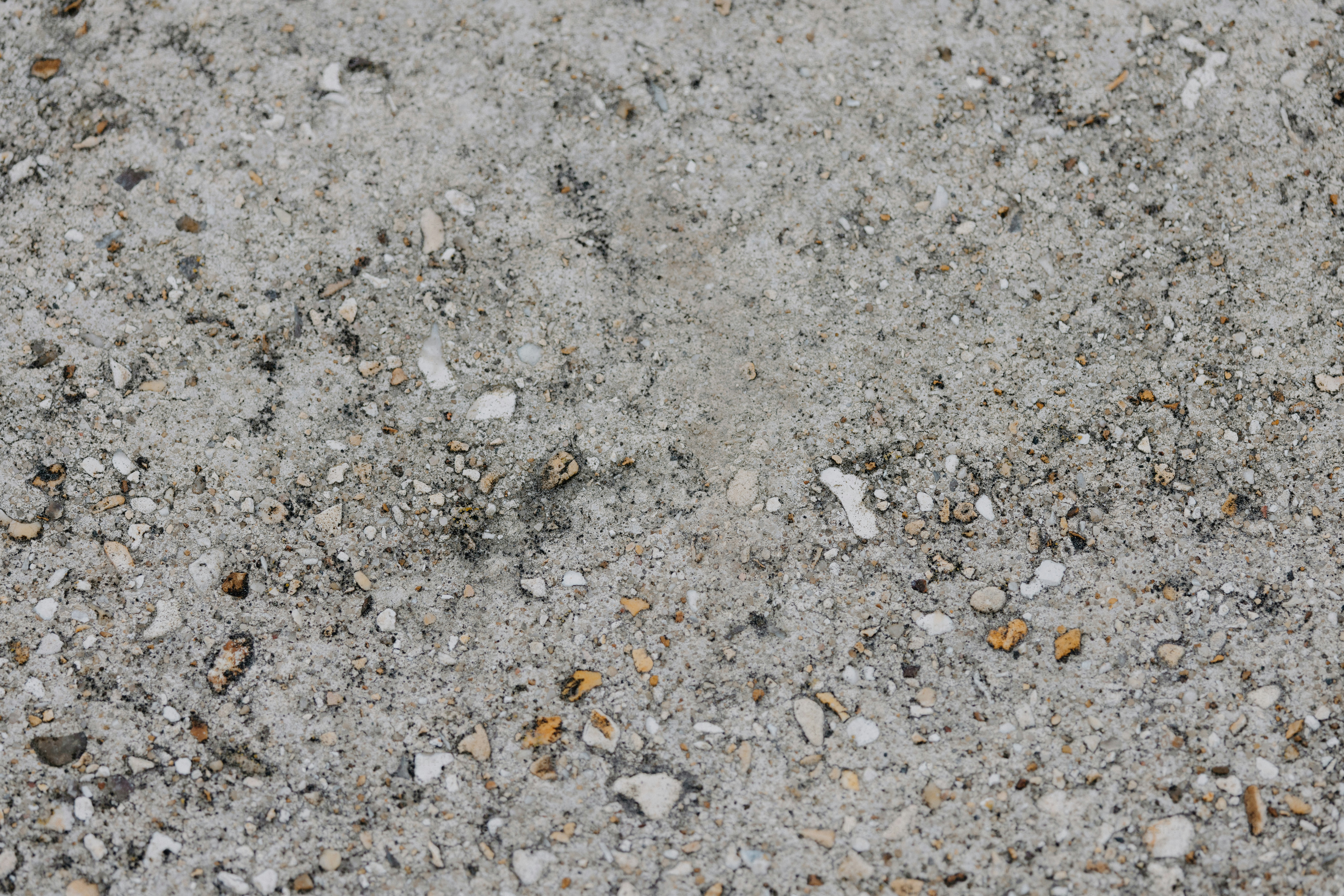 Gravel and sand form a textured, neutral surface. photo – Background ...