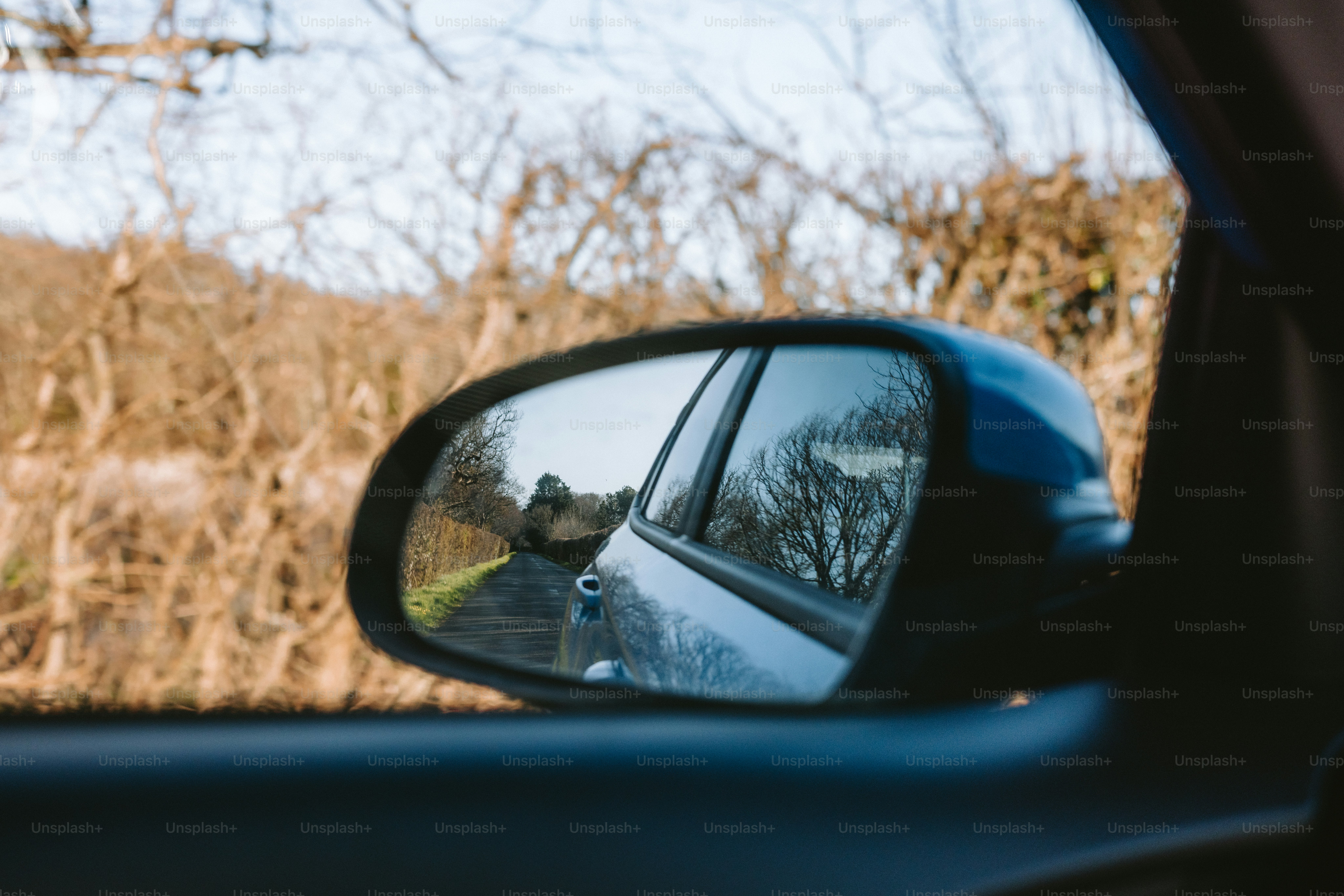 A car's side mirror reflects the road. photo – Countryside Image on ...
