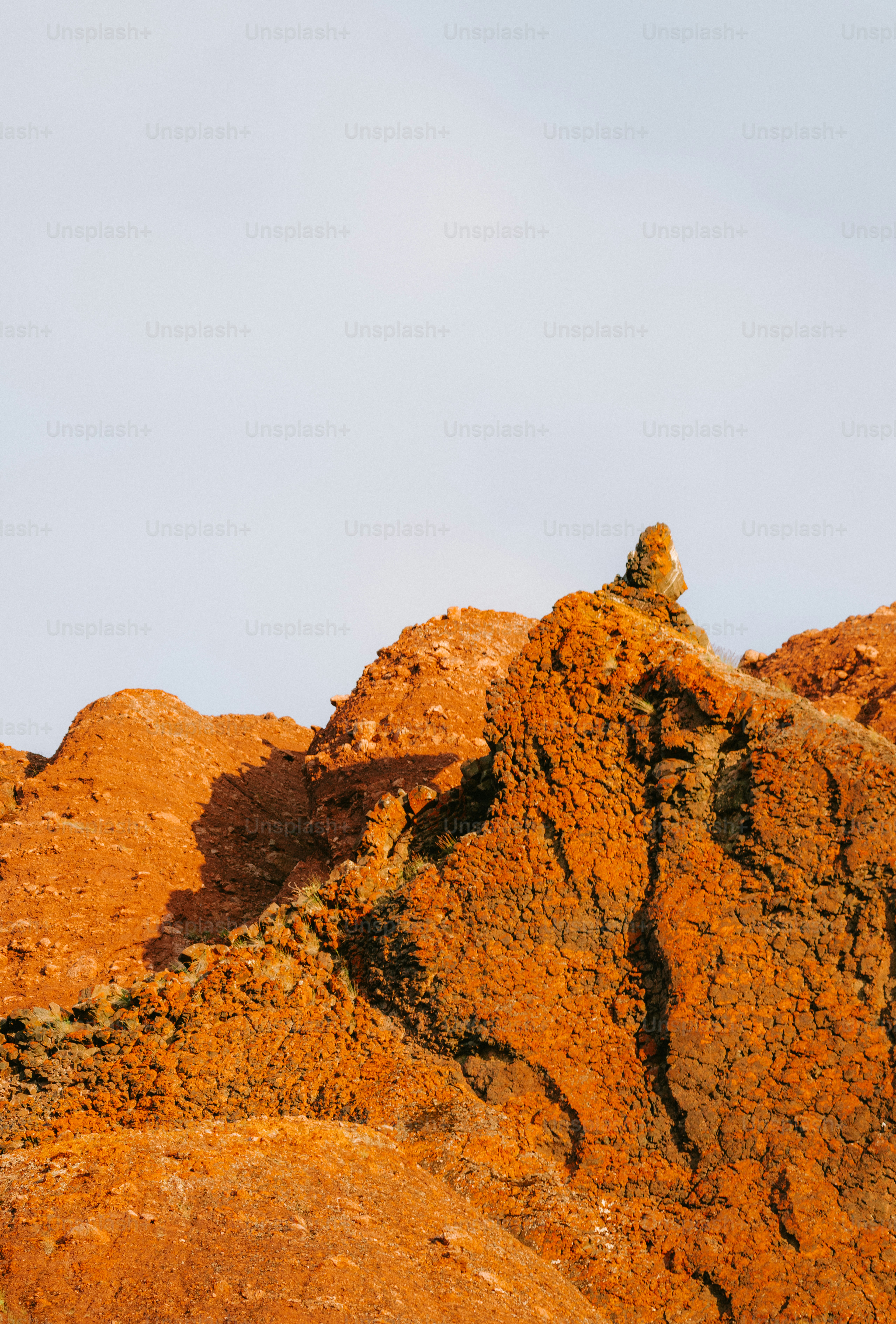 Orange rock formation against a pale sky. photo – Travel Image on Unsplash