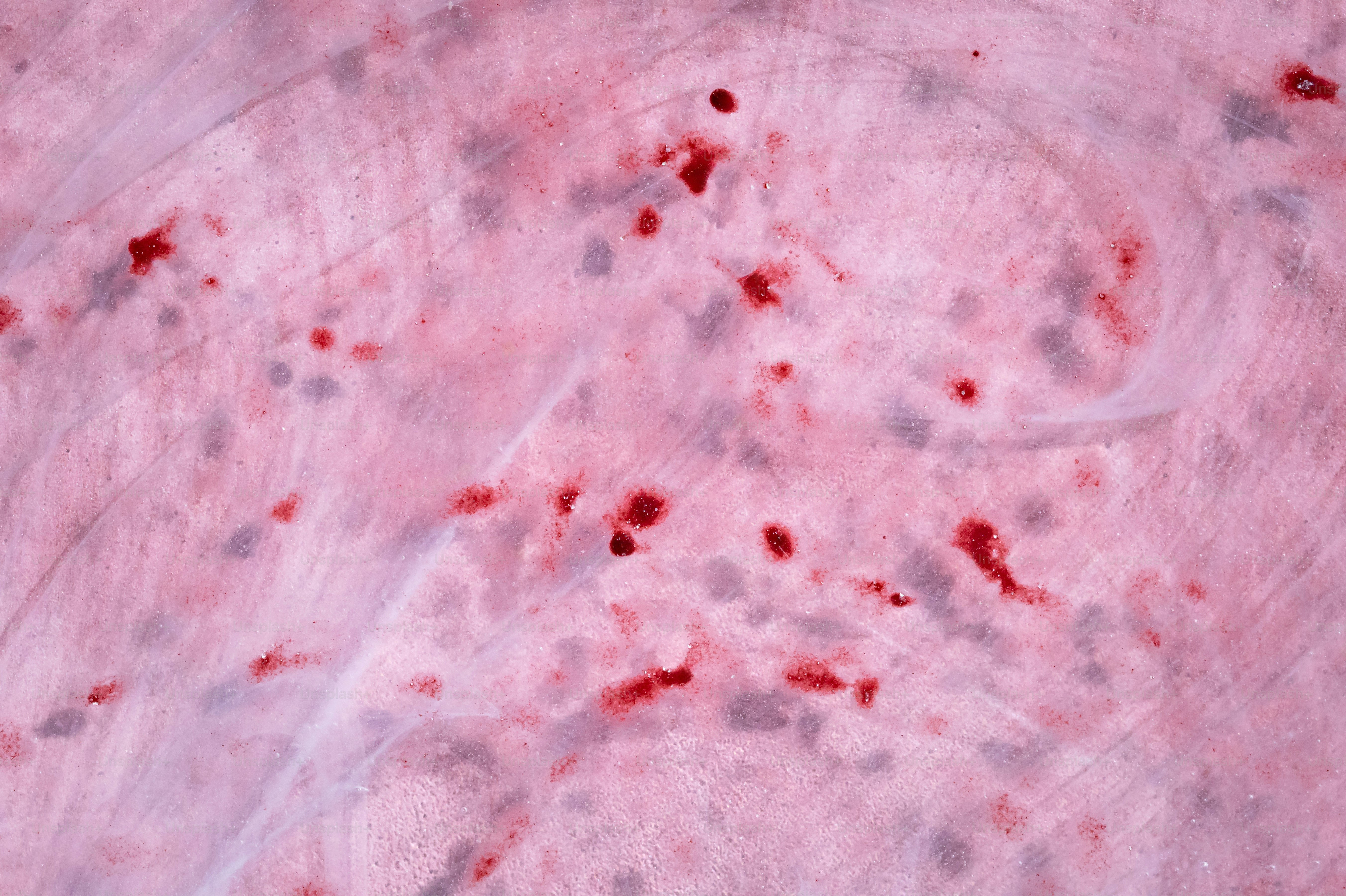 Red blotches appear on a pink, textured surface. photo – Wallpaper ...