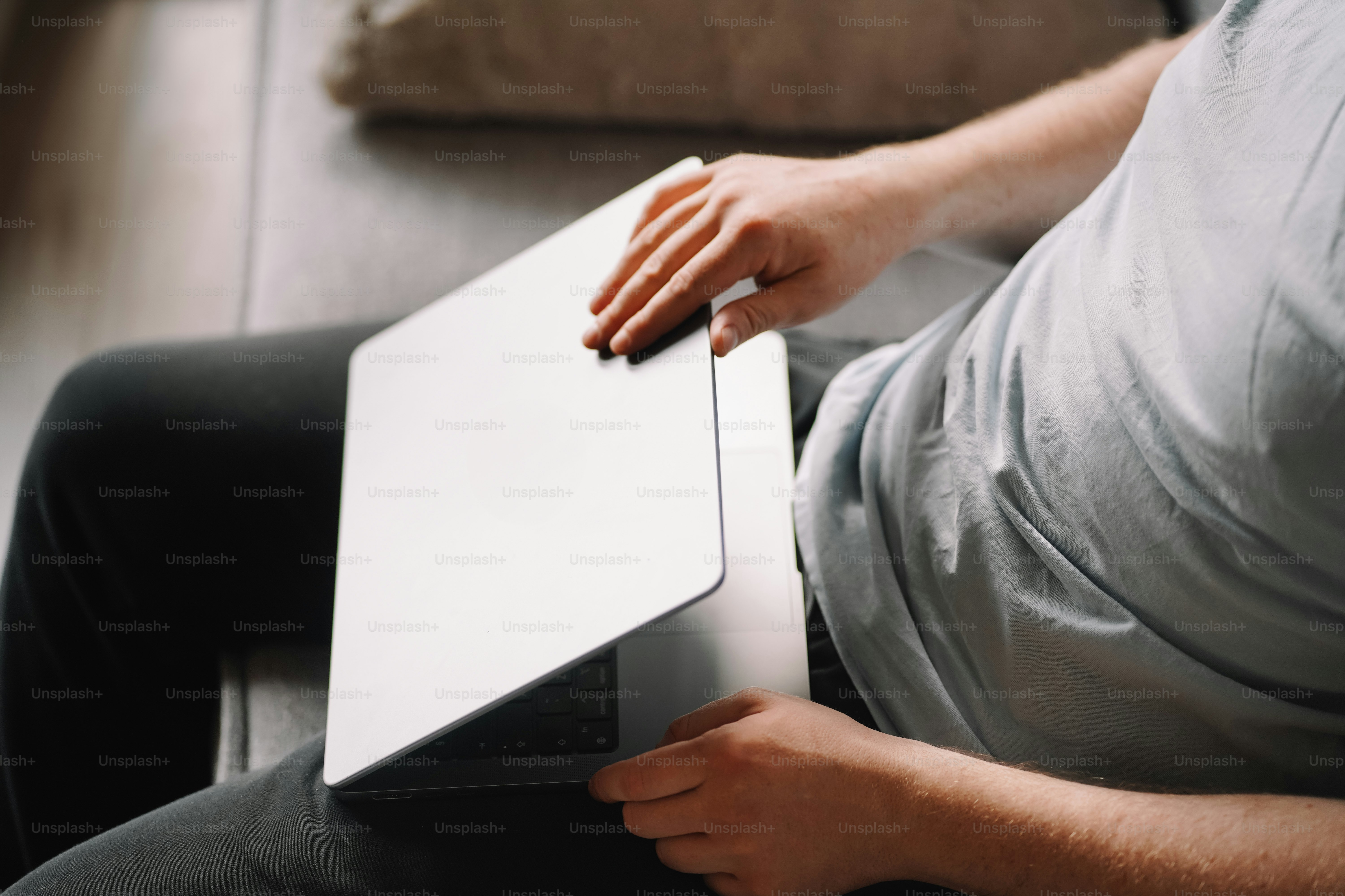 Man opens a laptop computer on his lap. photo – Technology Image on ...